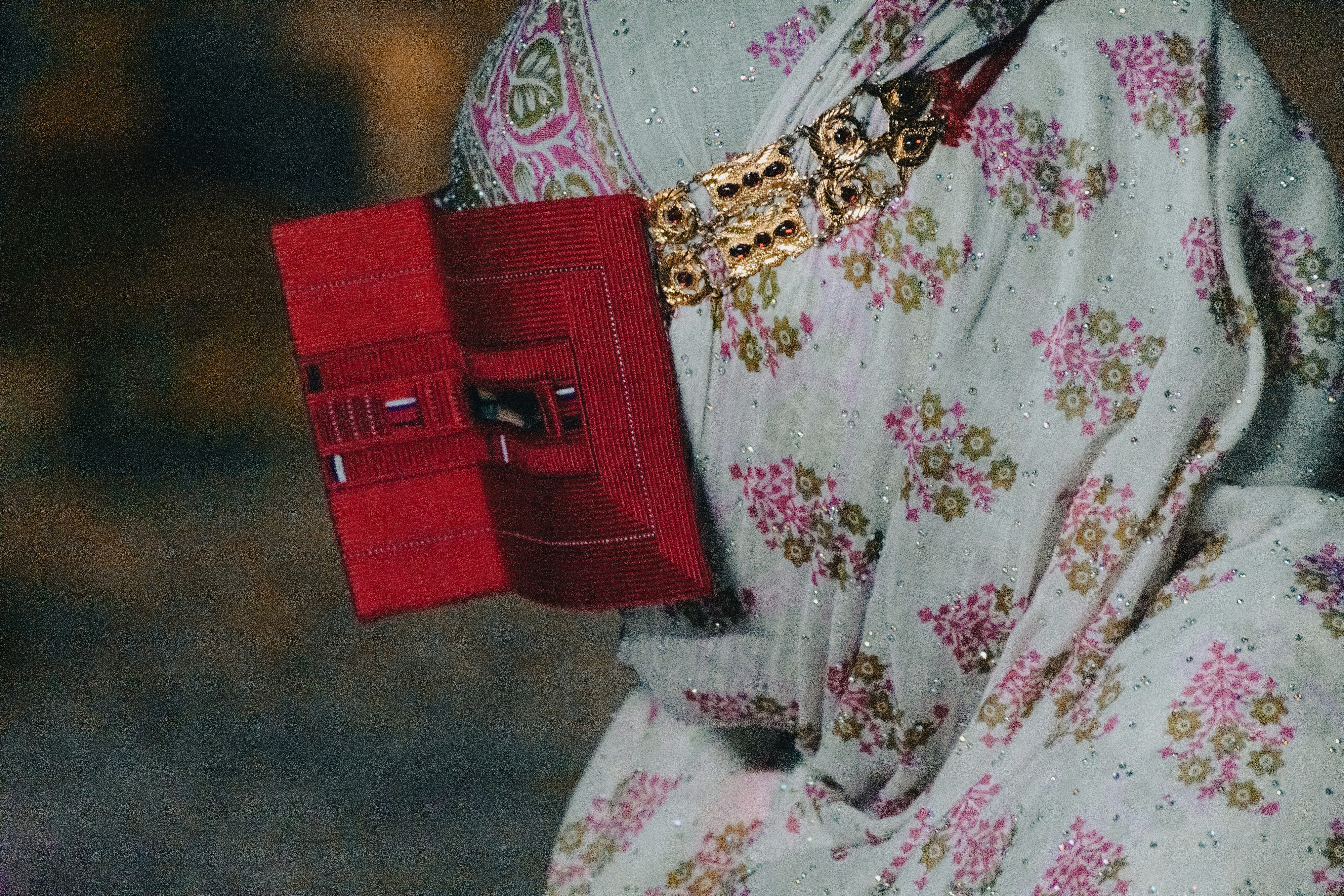 Ornate Sari and Red Pen Pocket: A Textured Moment in the Night