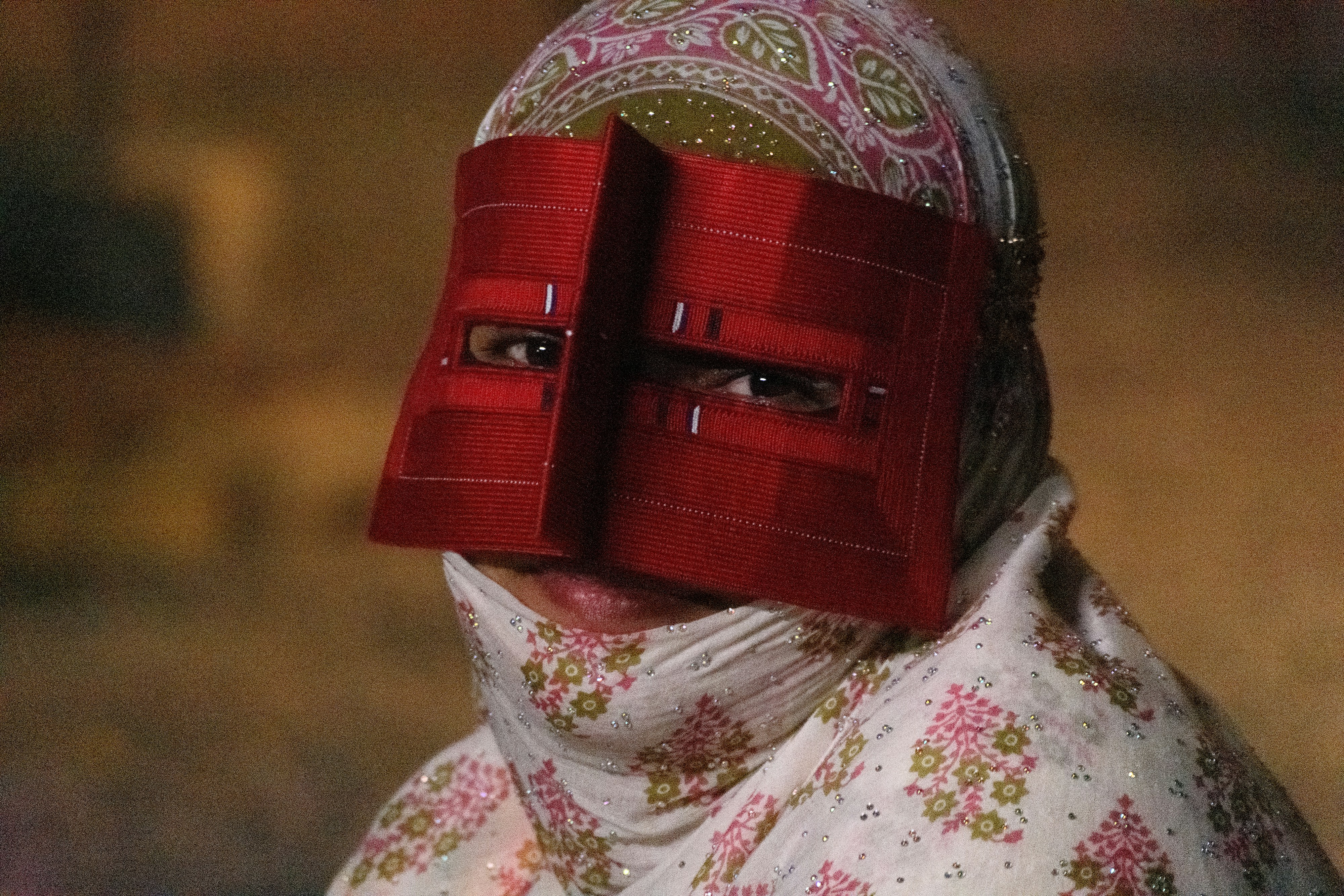 Red Mask, Floral Veil: A Portrait of Mystery and Color