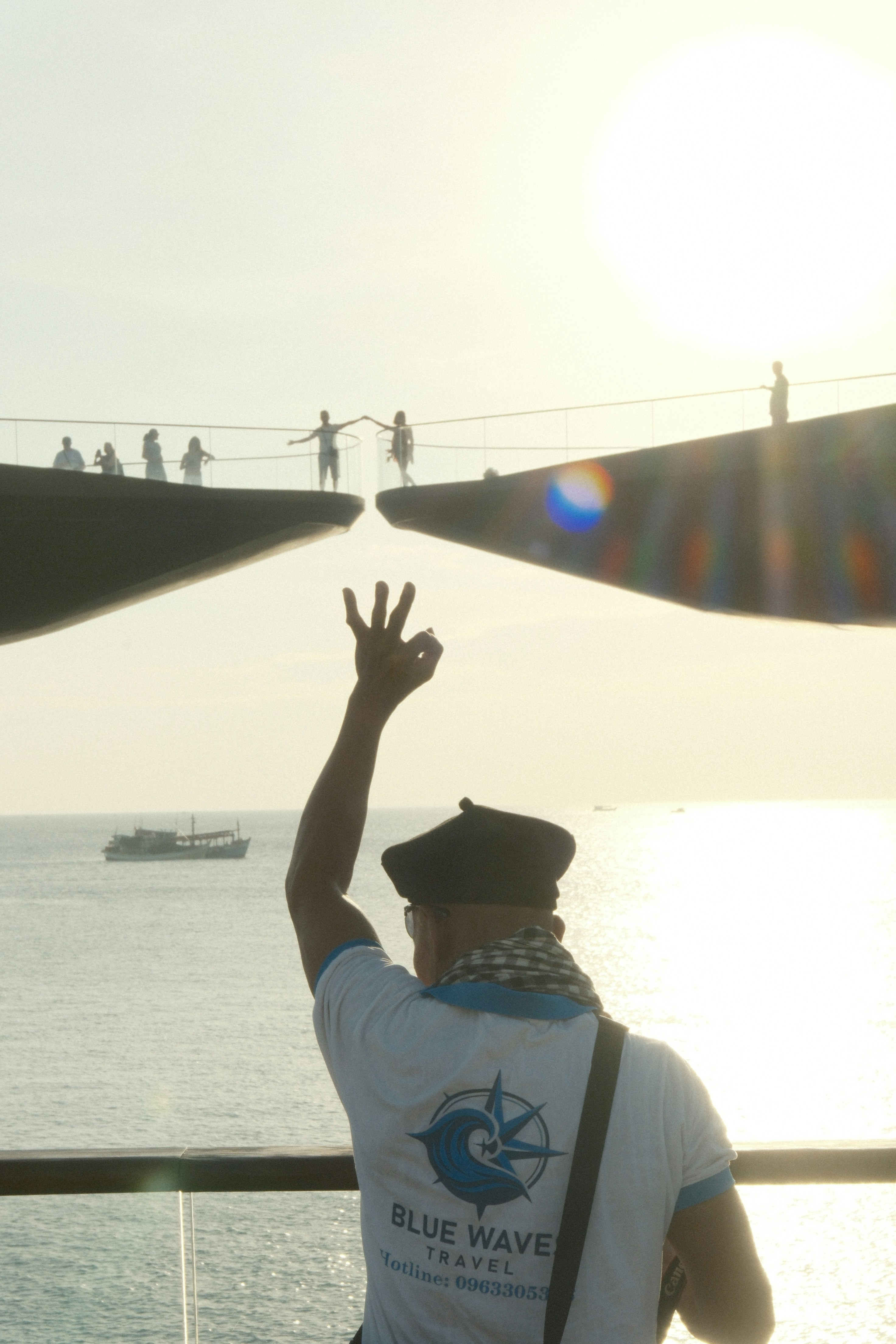 Hand Gesture Beneath a Distant Bridge of Light