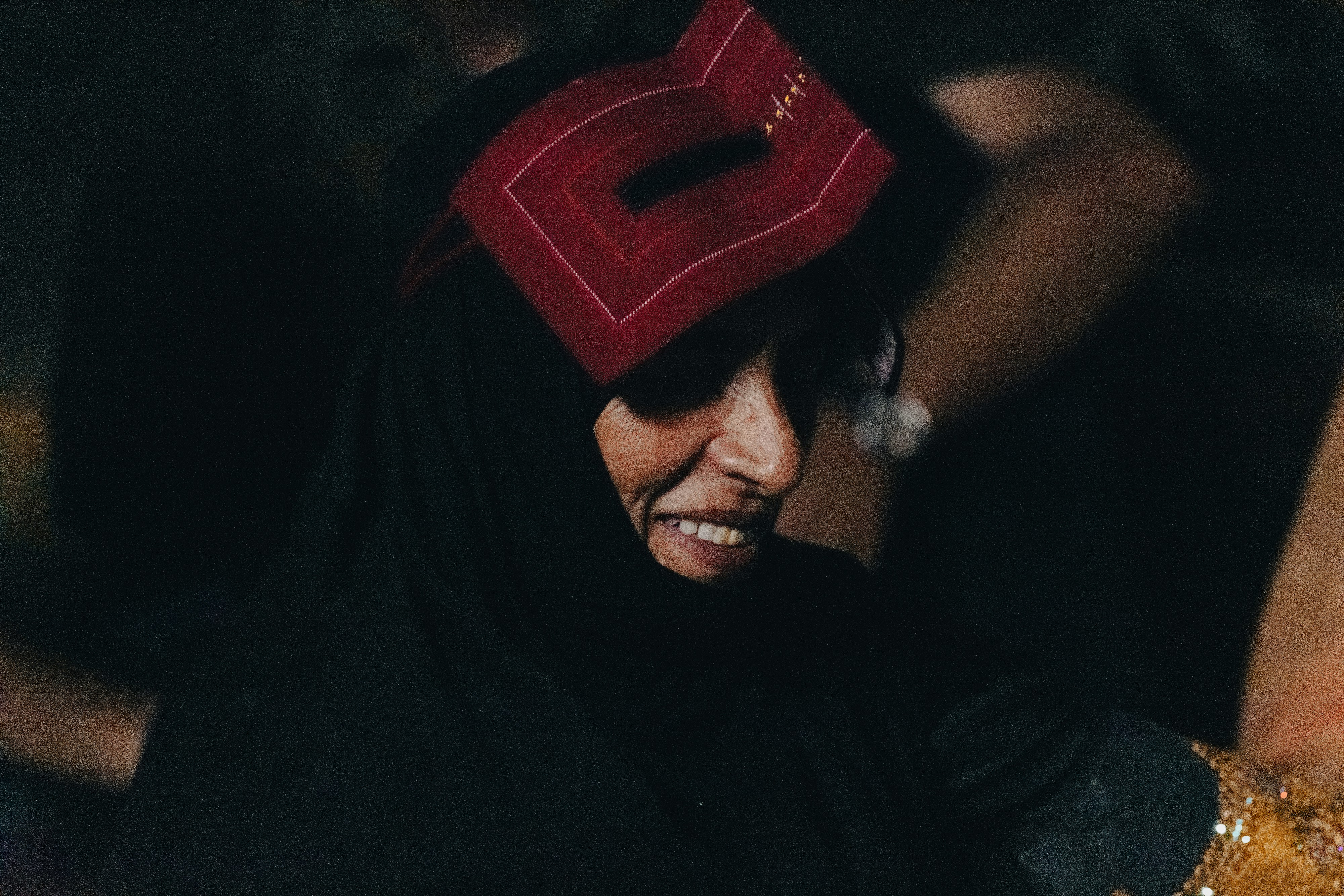 Red Headpiece, Silent Pose: A Portrait in Dim Light