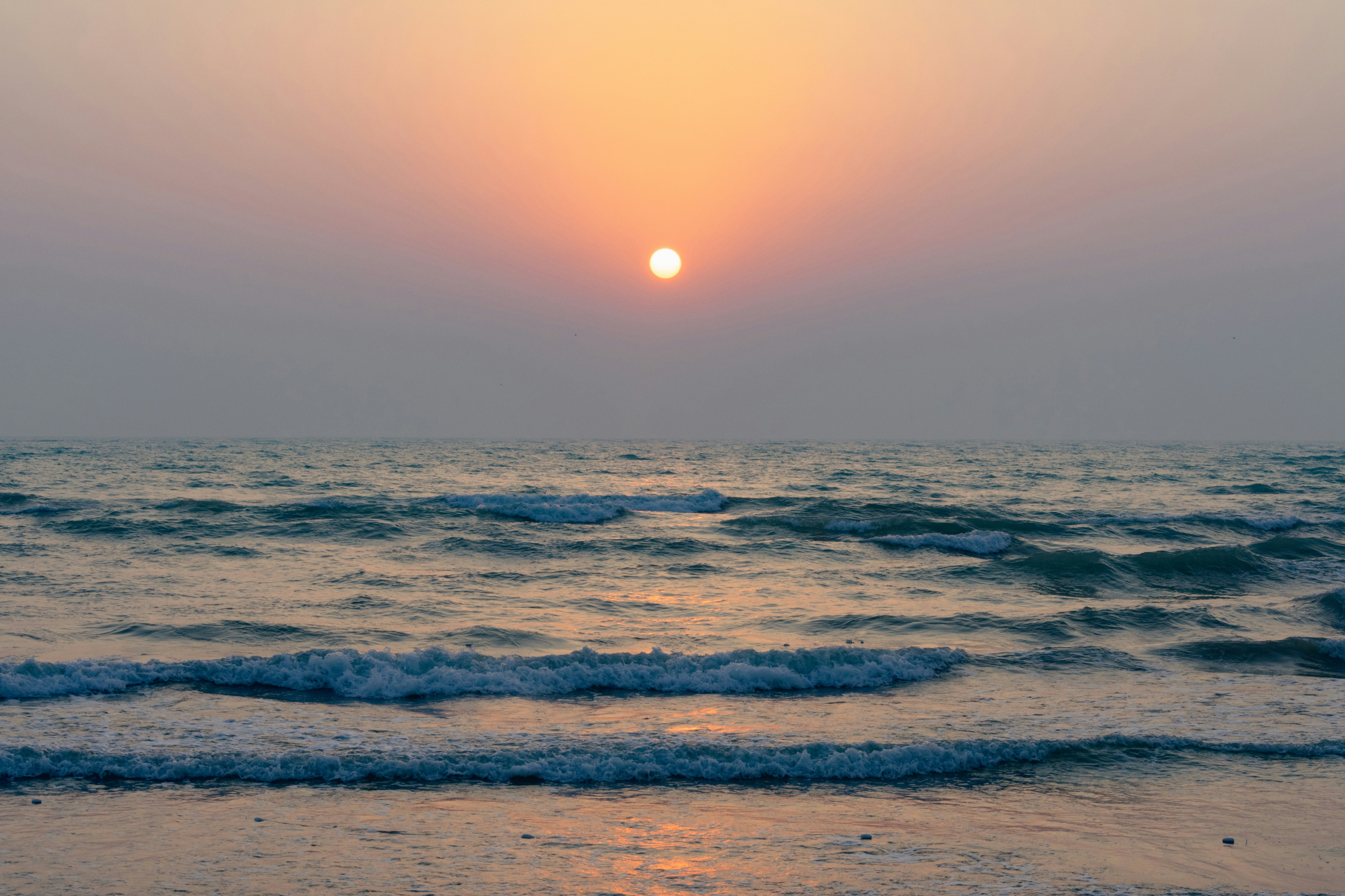 Sunlit Horizon: A Calm Evening Over Gentle Waves
