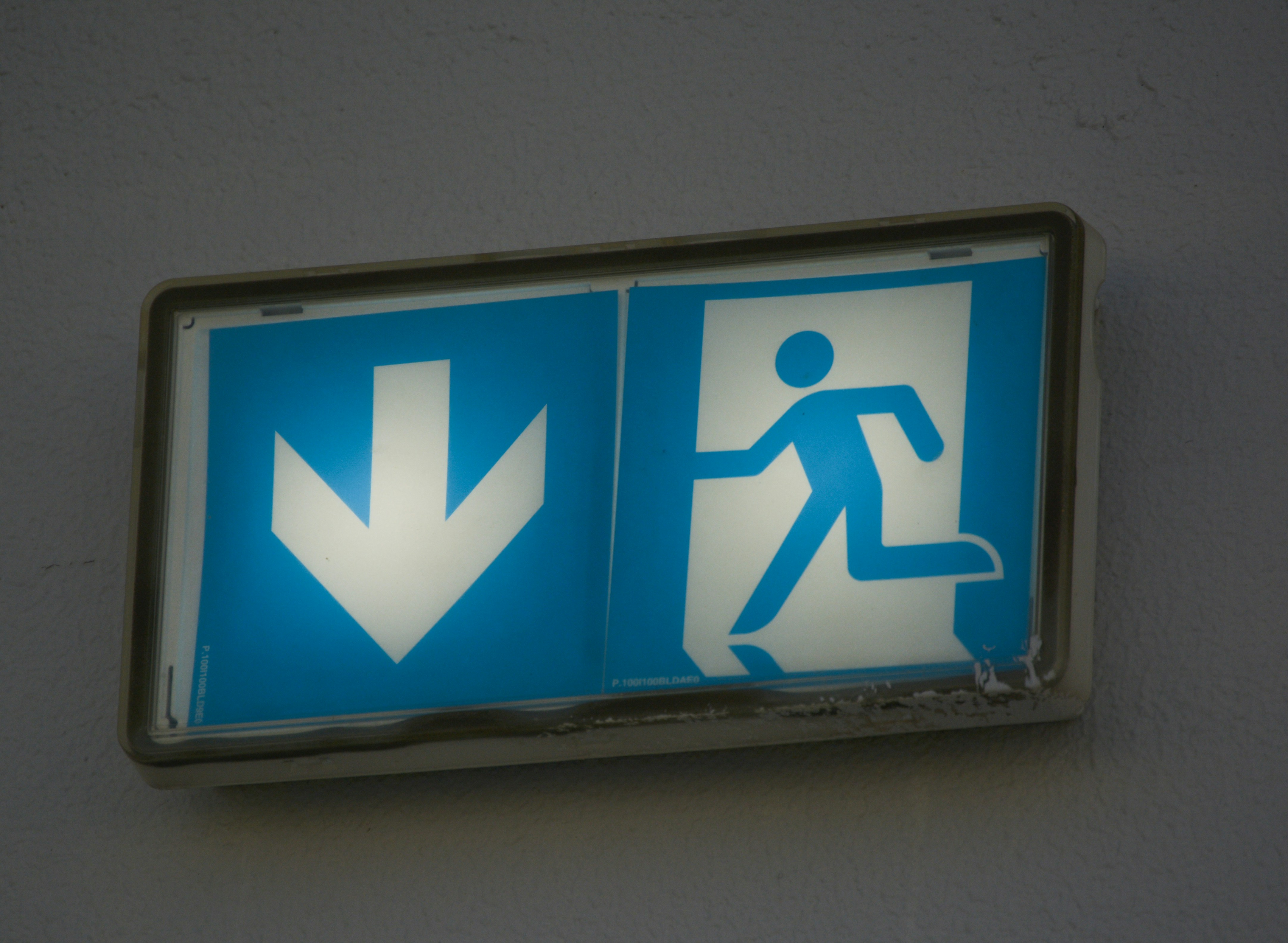 Blue Exit Sign Over a Weathered Door Frame
