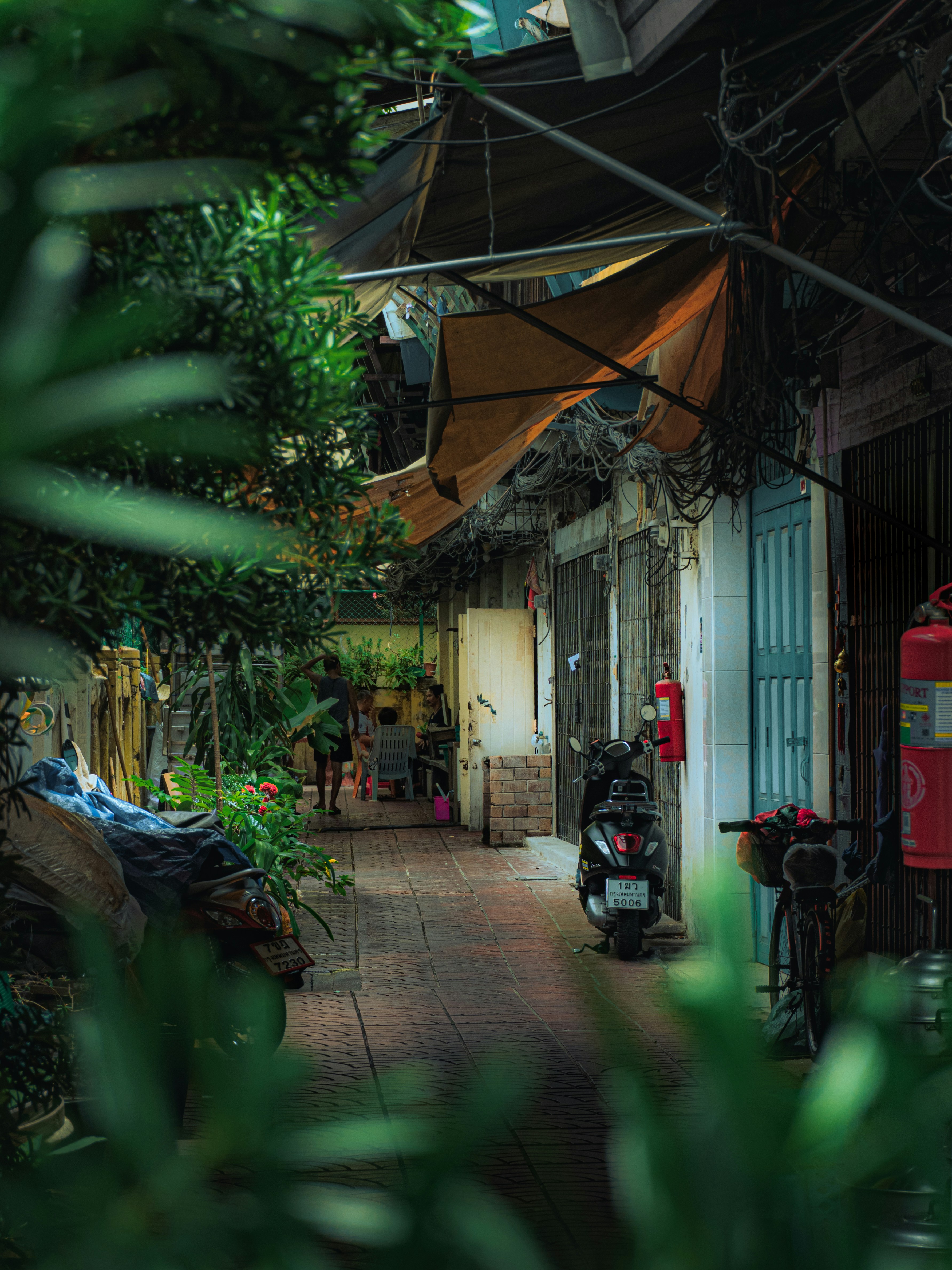 Narrow Alleyway in Evening Light with a Scooter and Neon Billboards