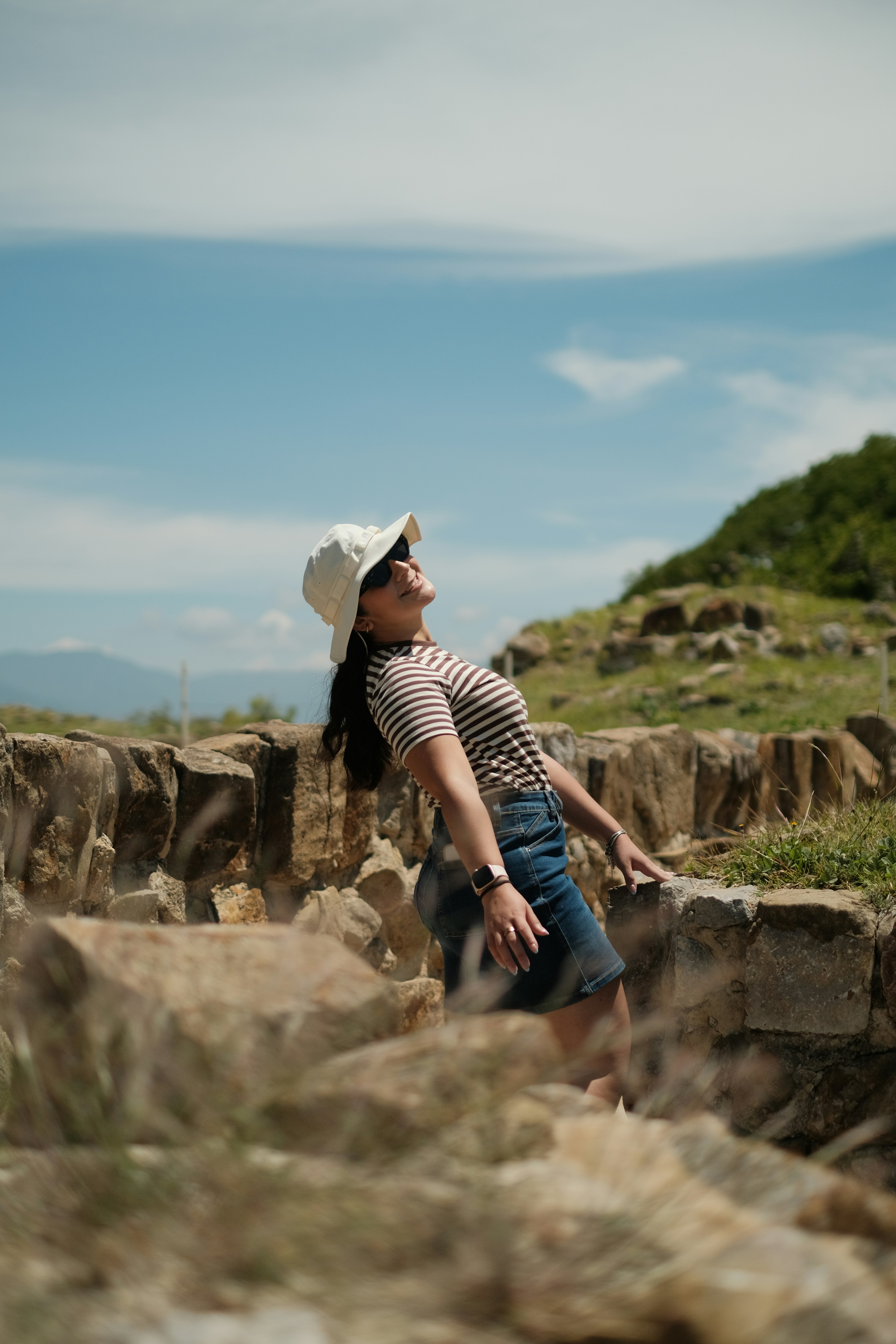 Sunlit Stride: A Lively Portrait by the Rocky Path