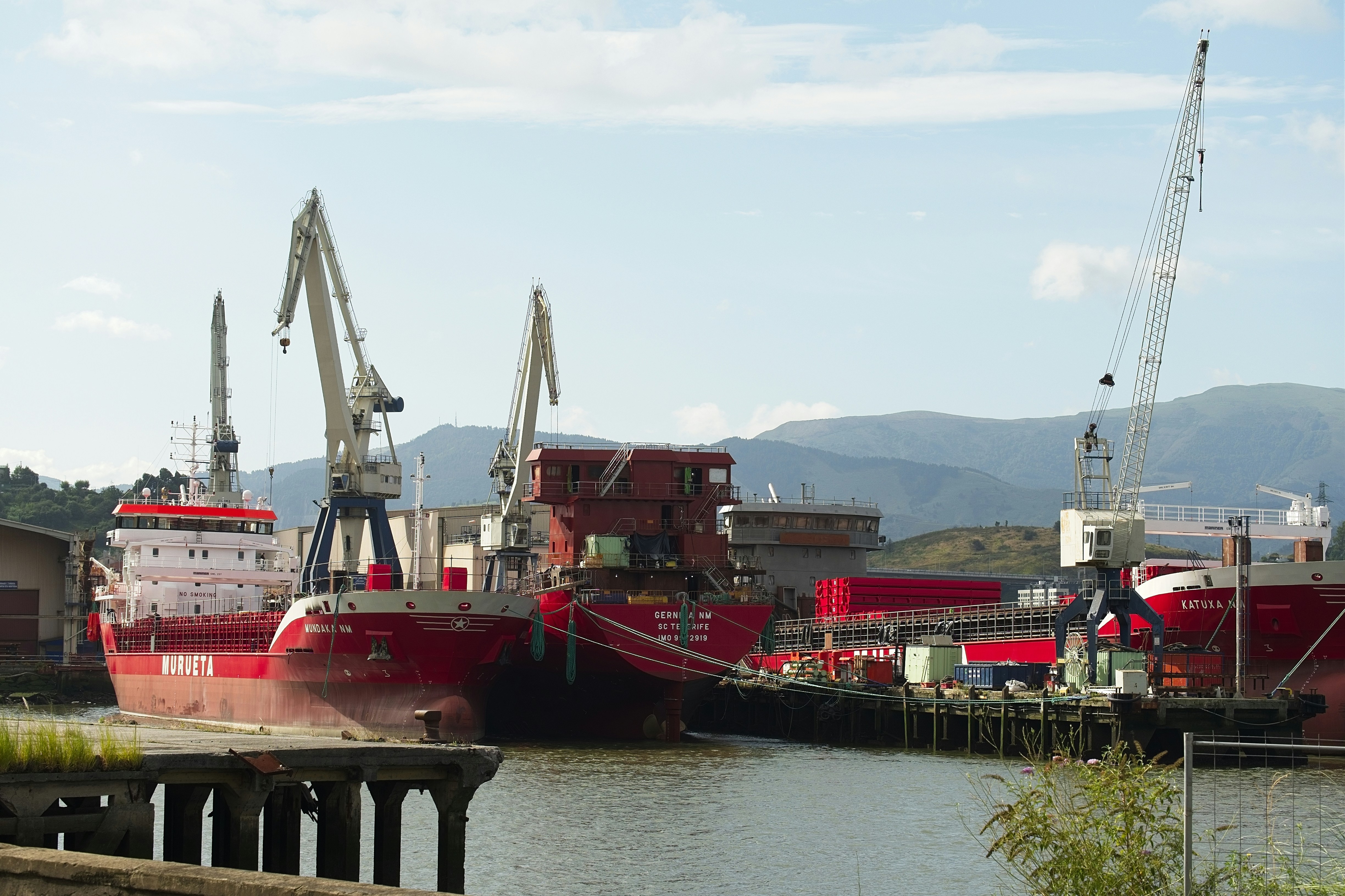 Harbor at Rest: Red Tugs and Crane Silhouettes