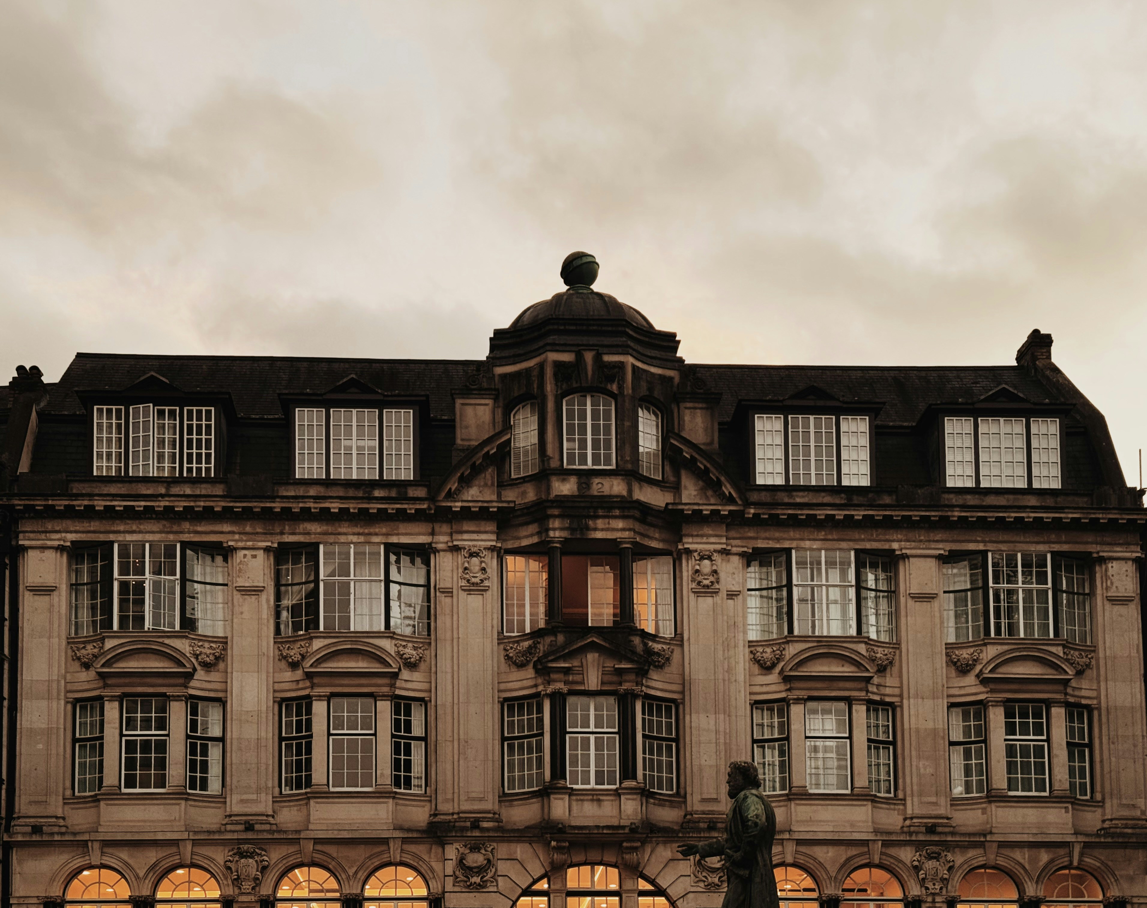  symmetric façade of a historic stone building under a moody sky