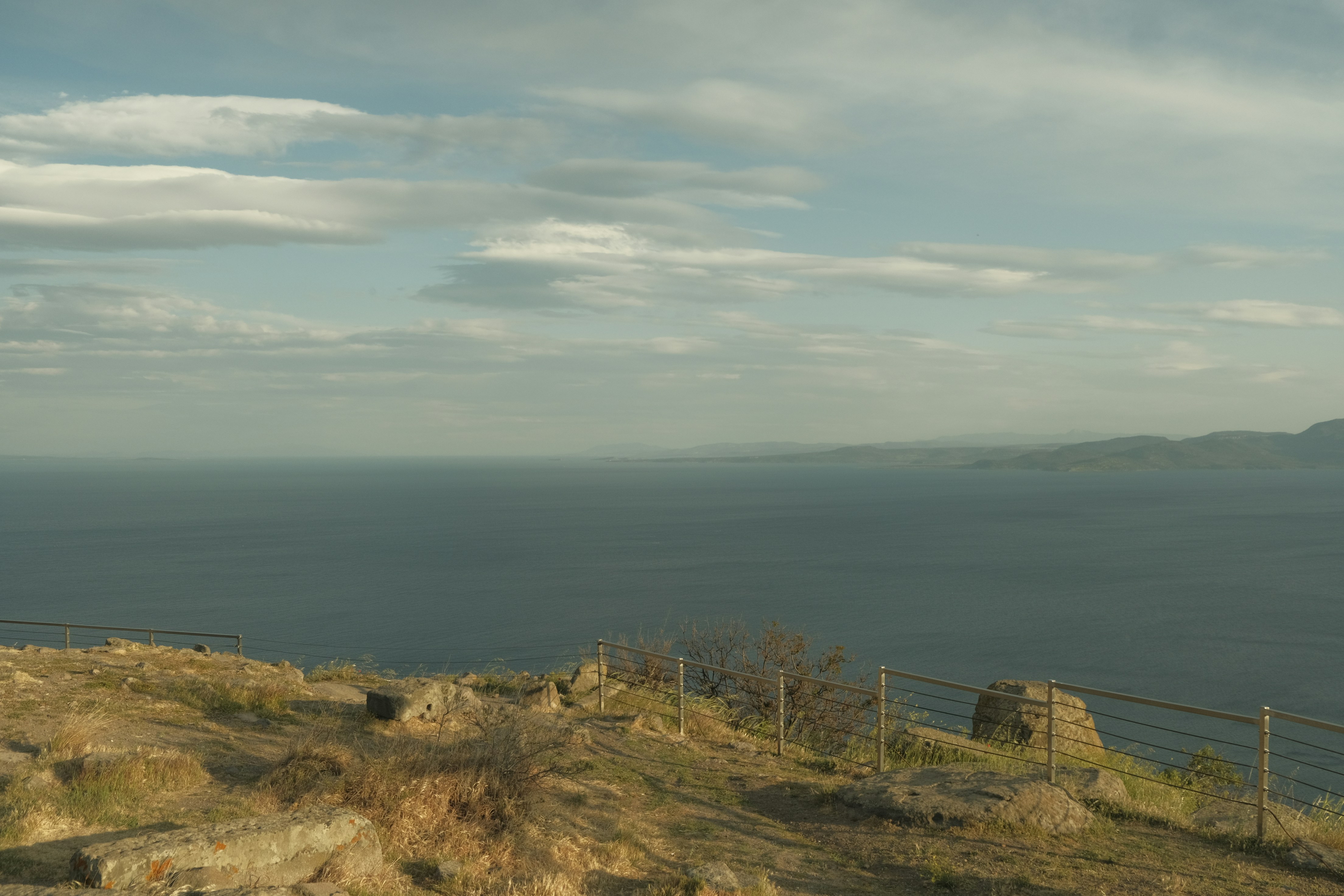 Cliffside Vista: Ocean Horizon Beyond Weathered Rails