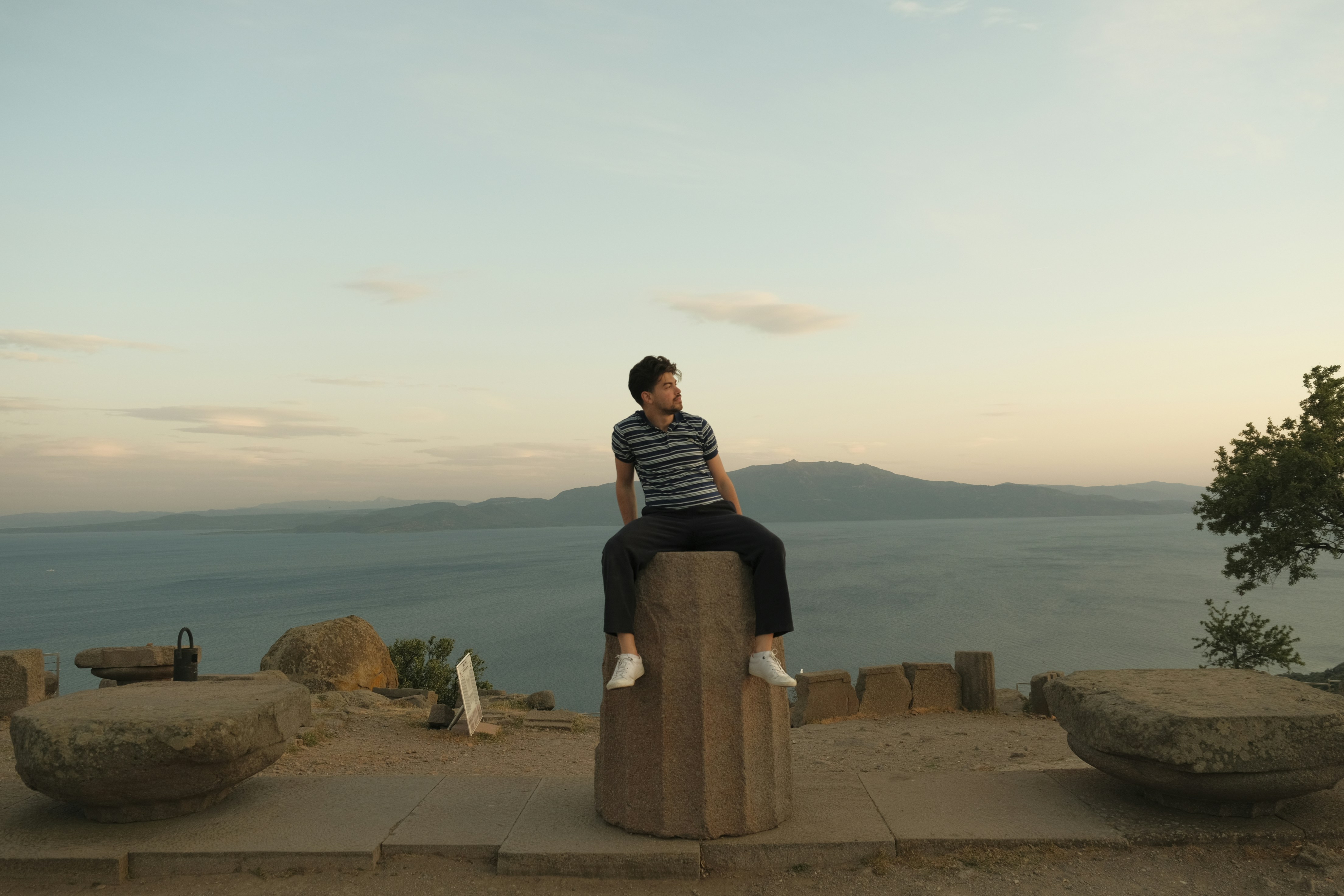 Horizon Seat: A lone figure on a stone pedestal overlooking the sea