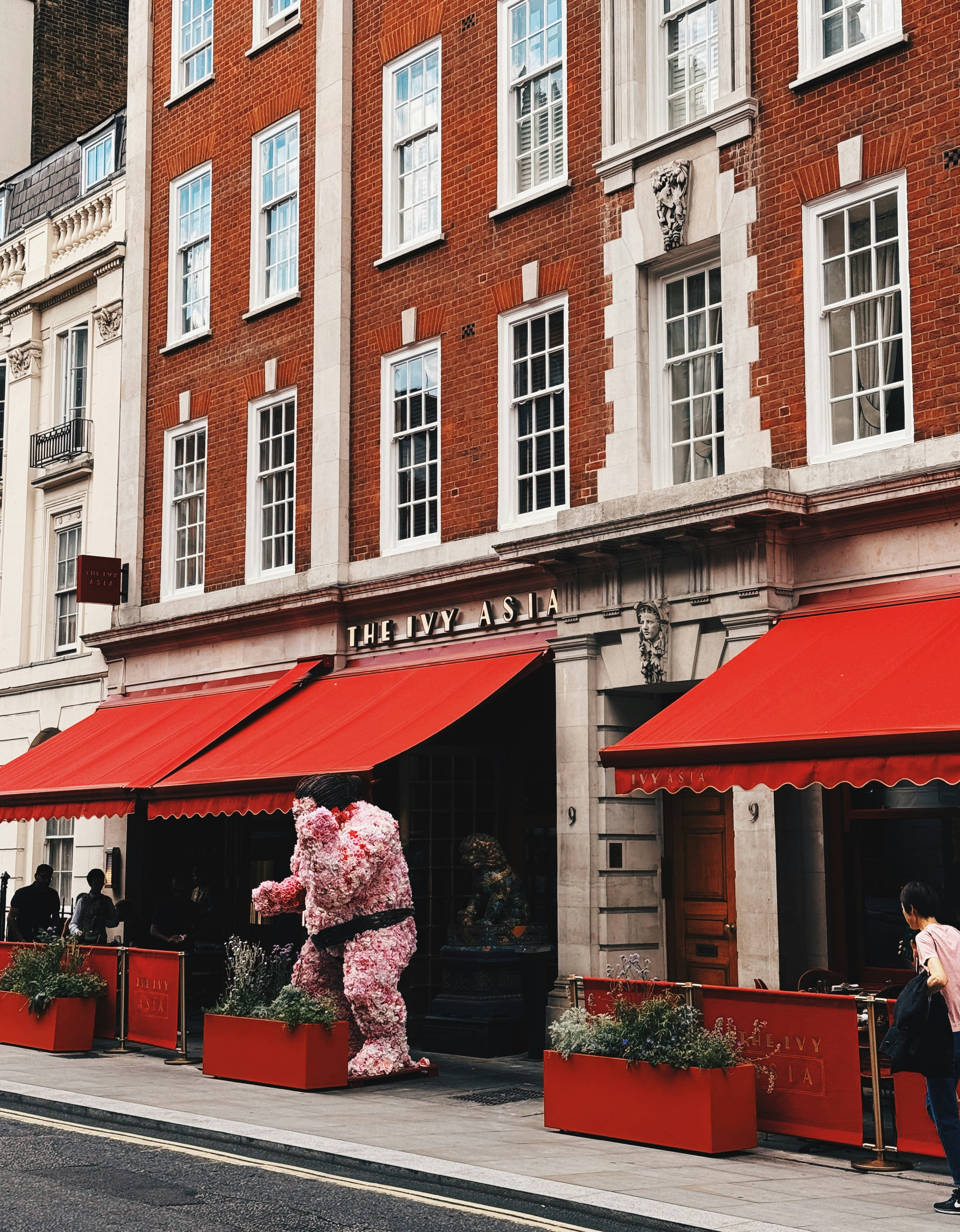 Red-awned Café: A Floral Figure at the Facade of Ivy Lane