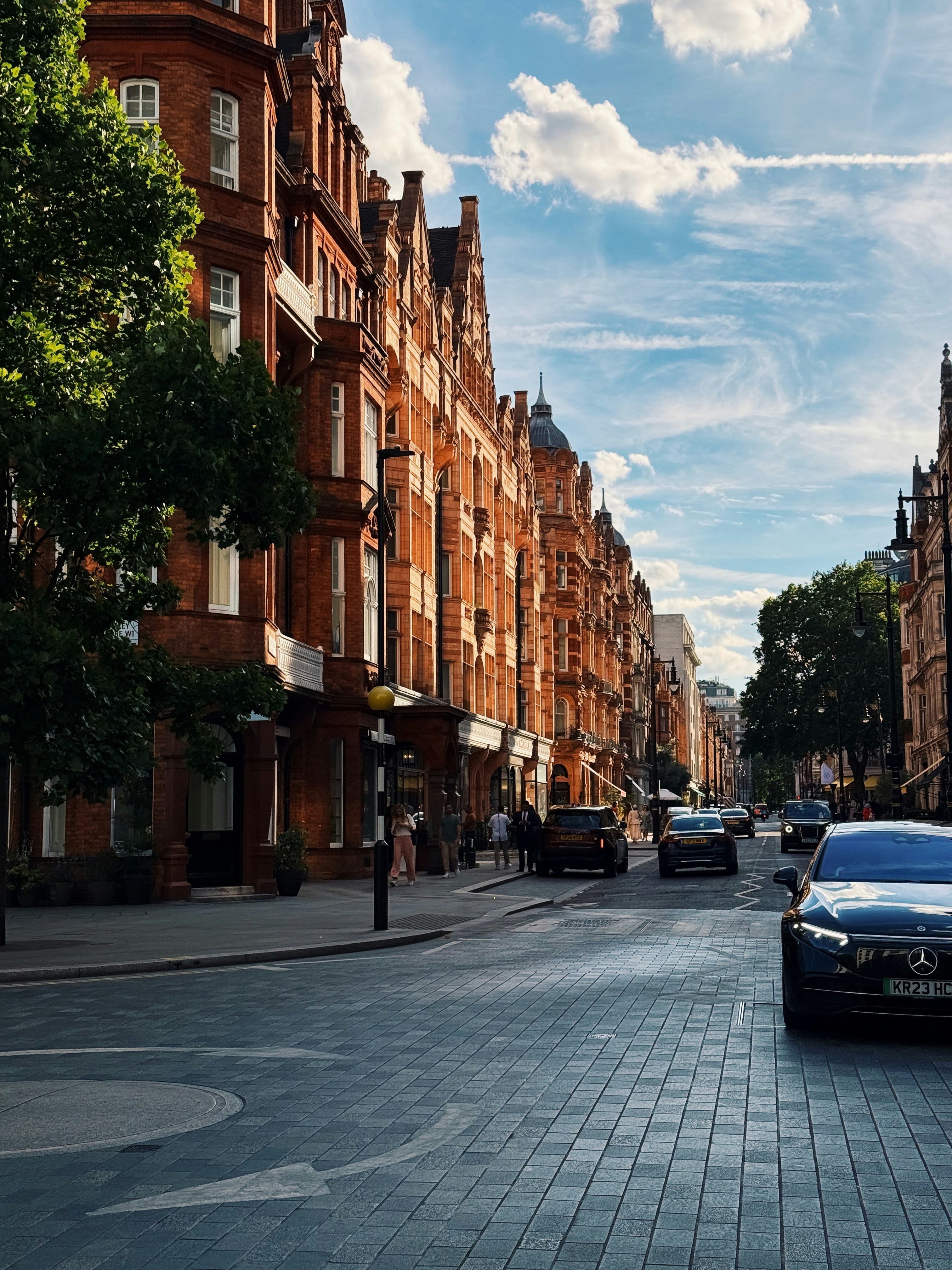 Red Brick Street: Morning Parade of Vehicles and Architecture