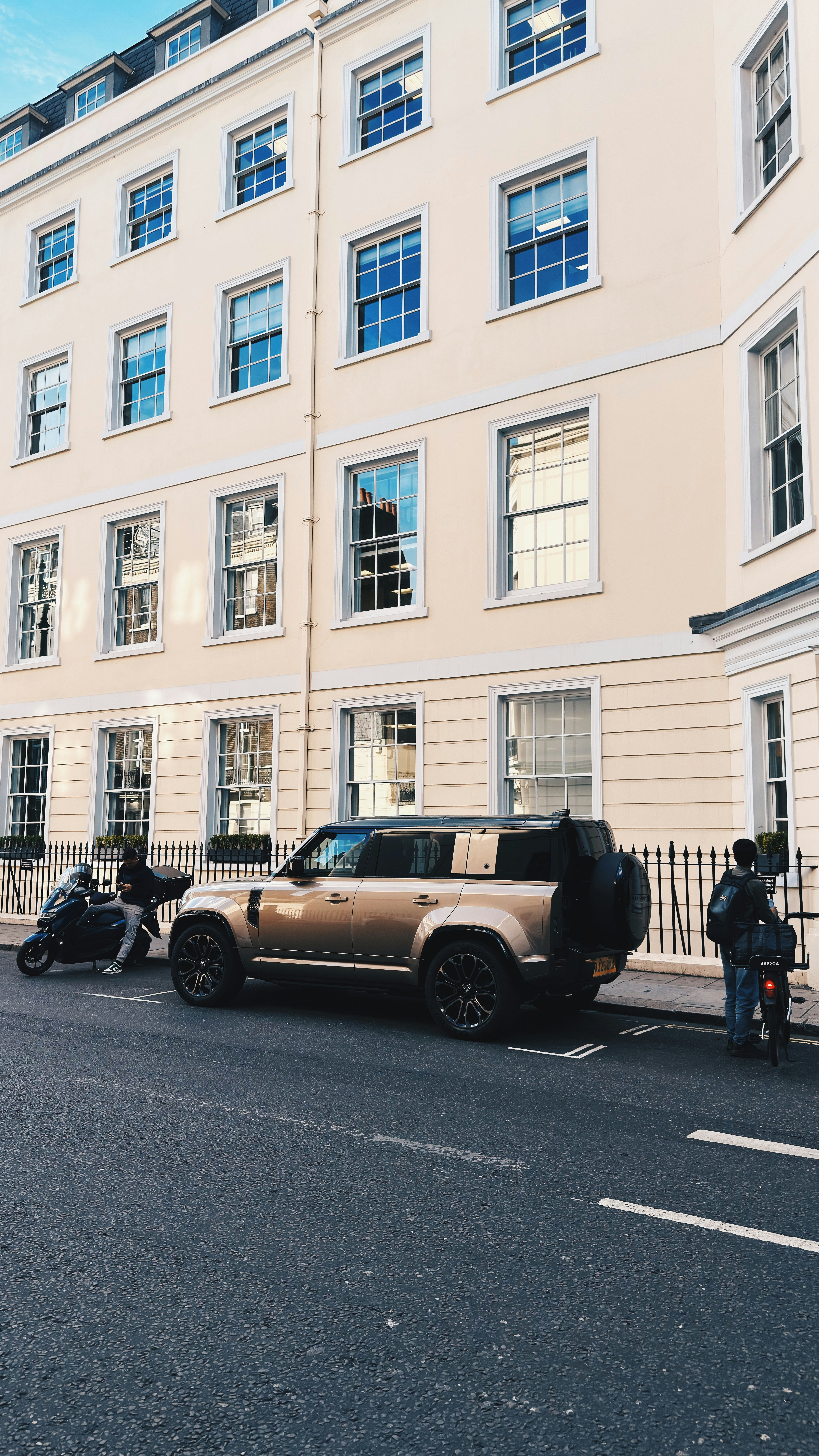 City Street Portrait: Beige Townhouse, SUV, and Passersby