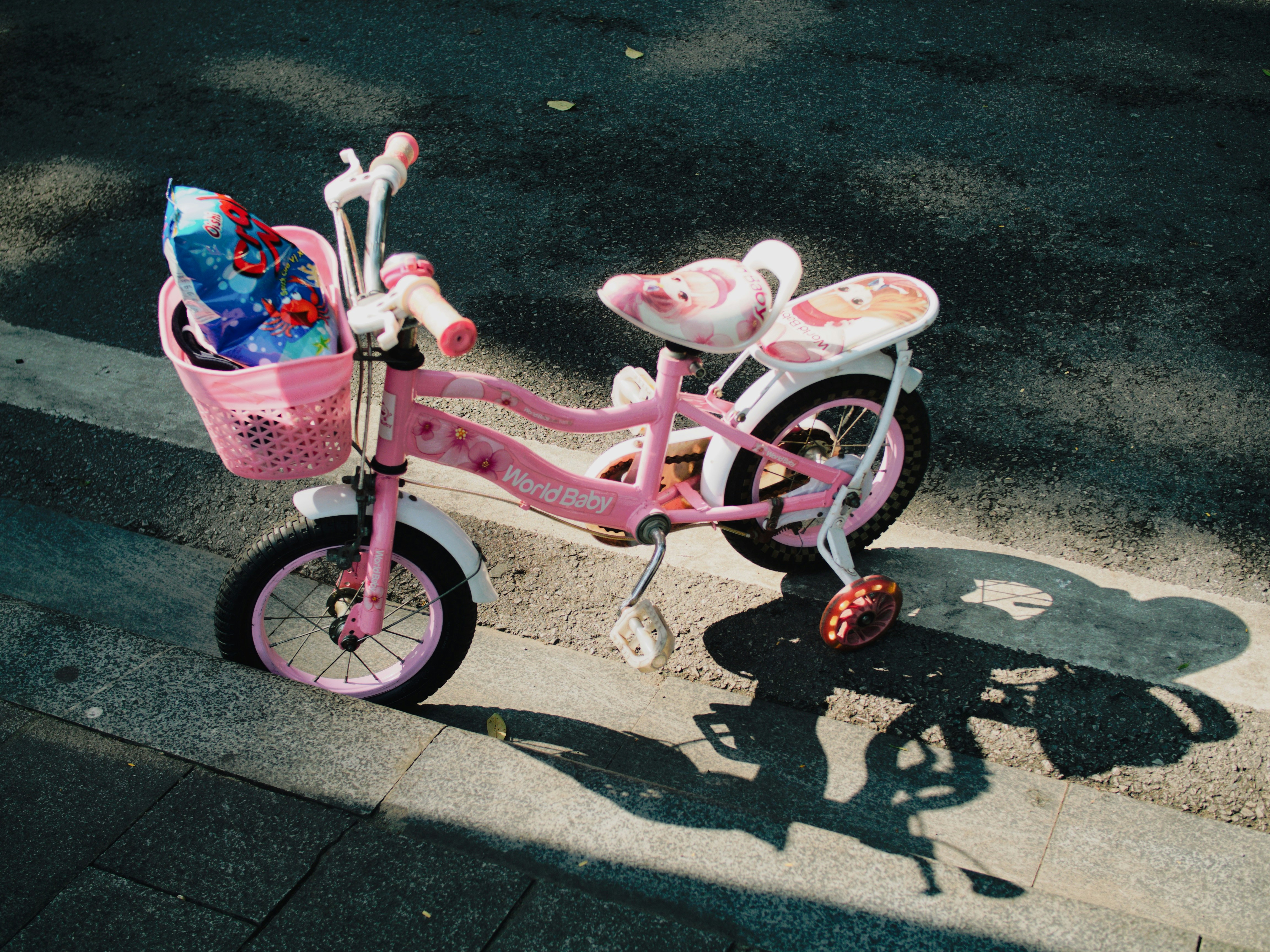 Pastel Pedal Power: A Tiny Pink Bicycle in Shade