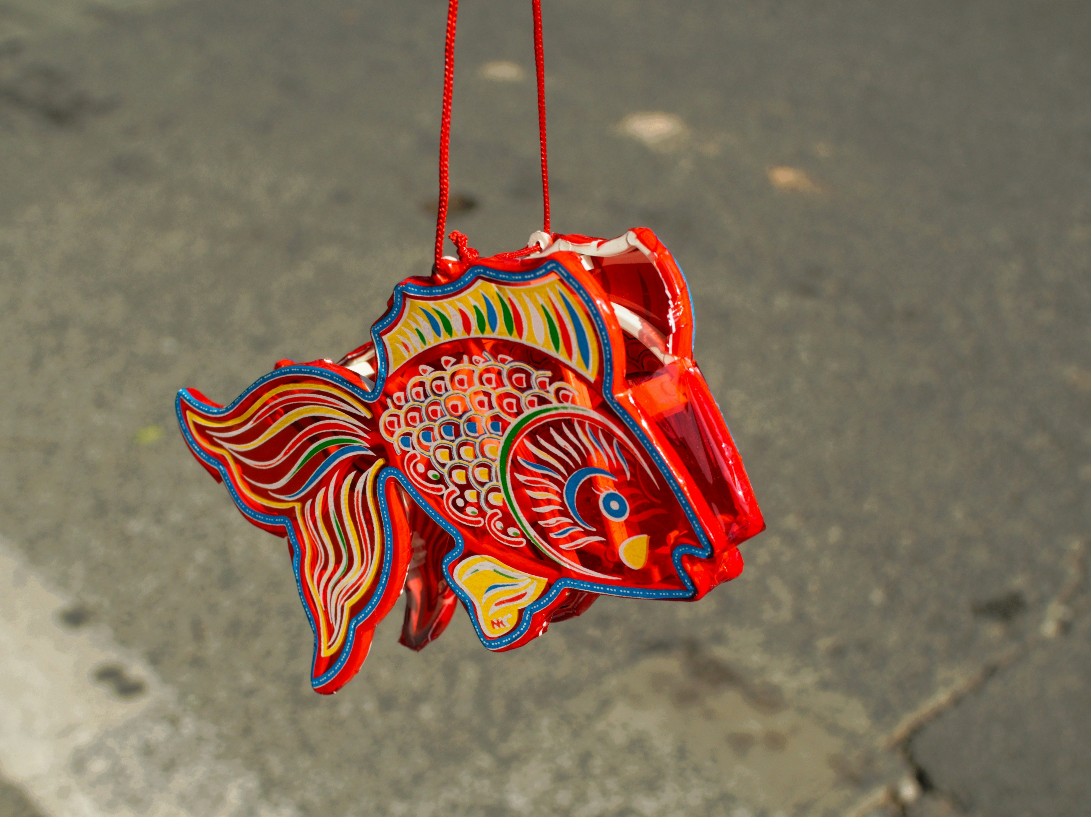 Vivid Fish Charm: A Colorful Toy Hanging in Focus