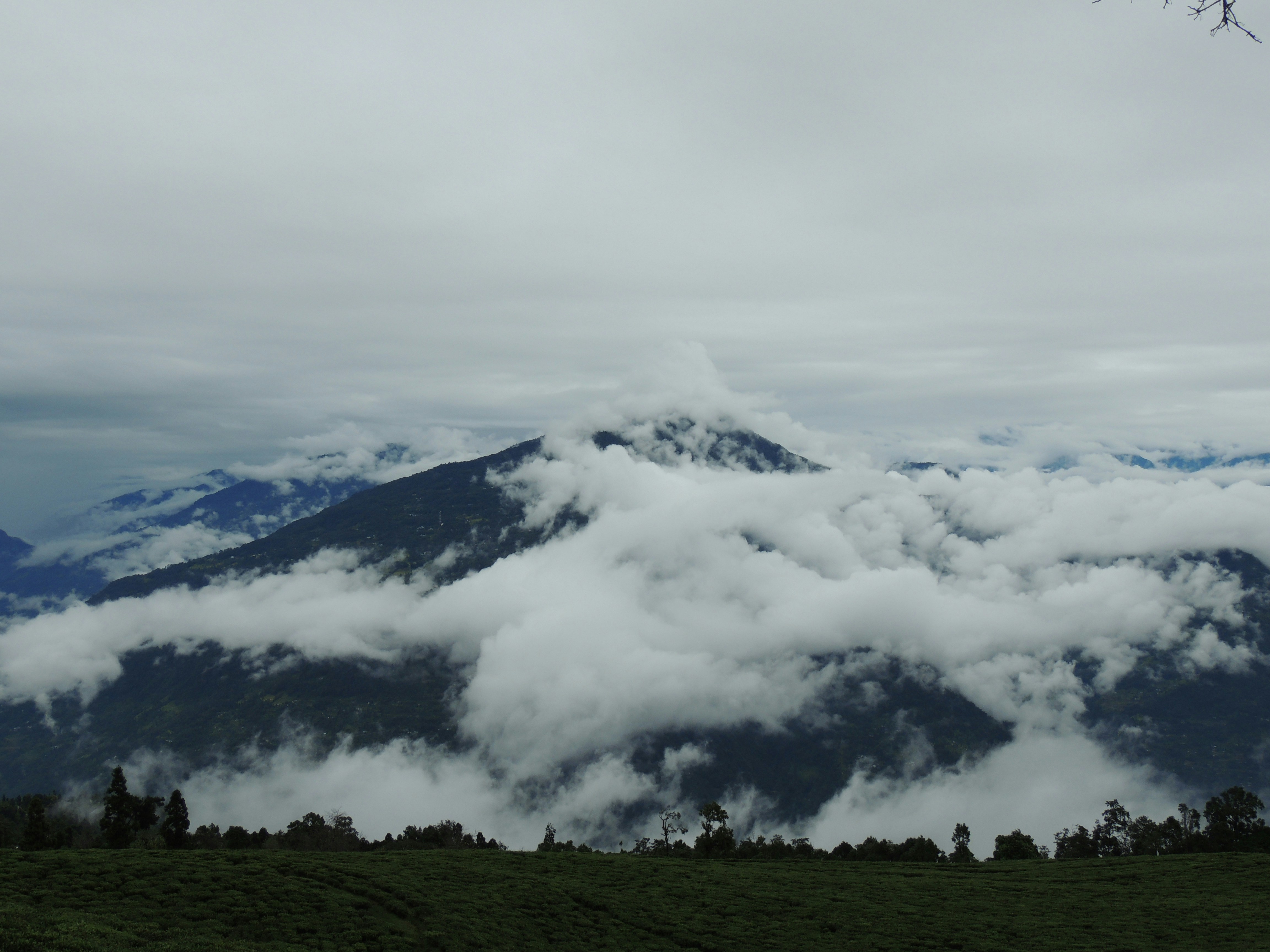 Cloud-kissed Peak Emerges from a Misty Valley
