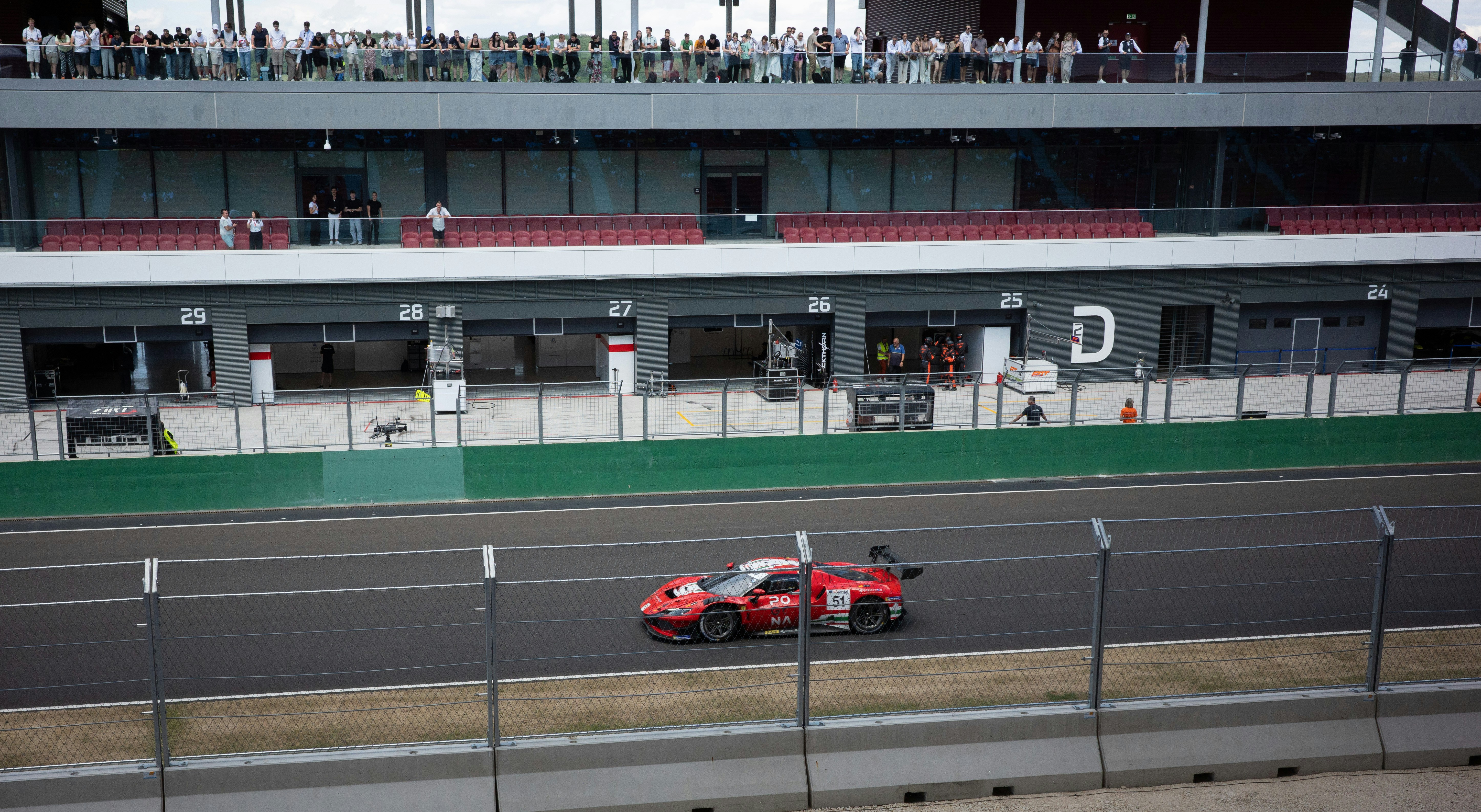 Red GT Leans into the Curve at the Pitwall