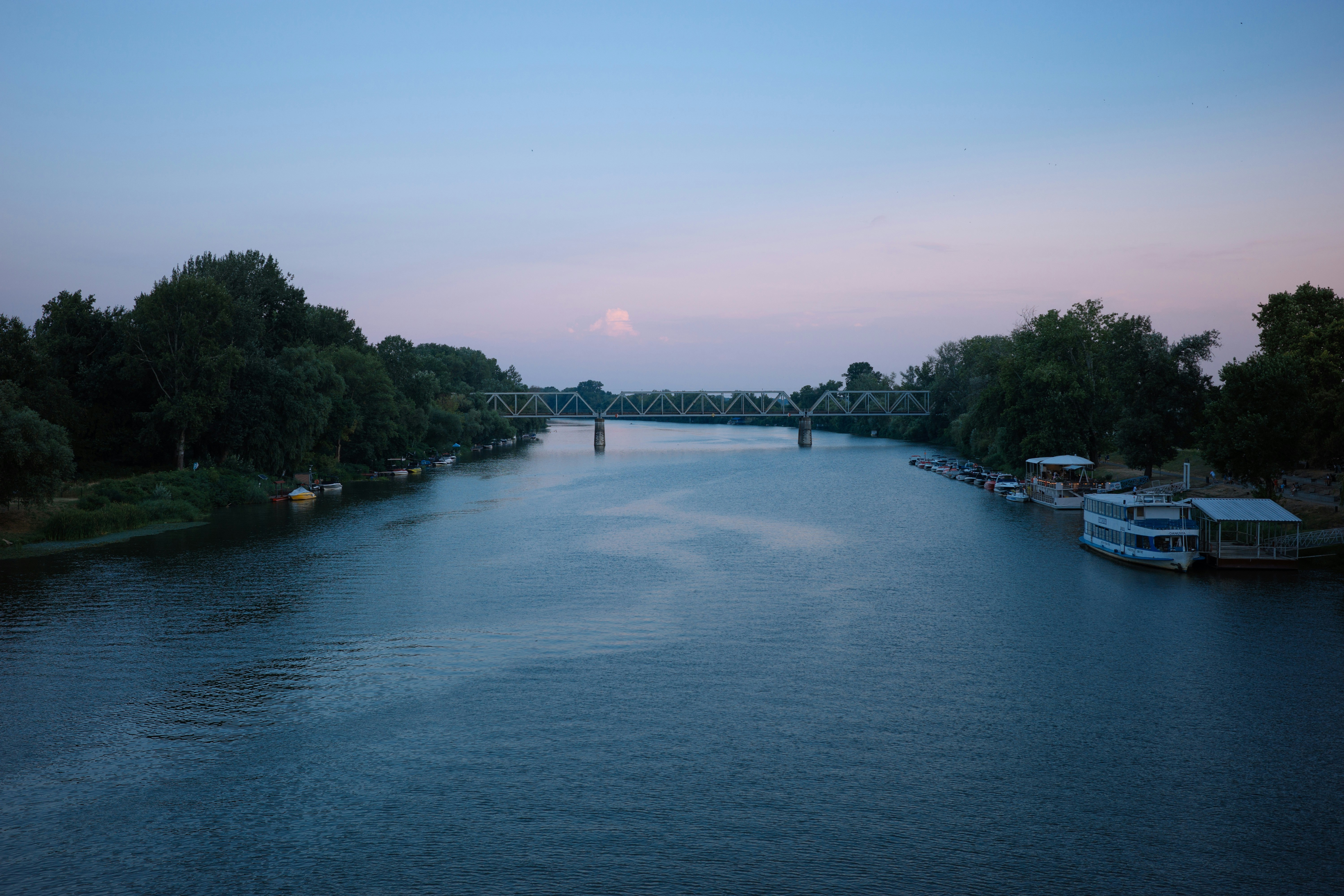 Evening River Crossing: A Quiet Aerial View of the Bridge and Boats