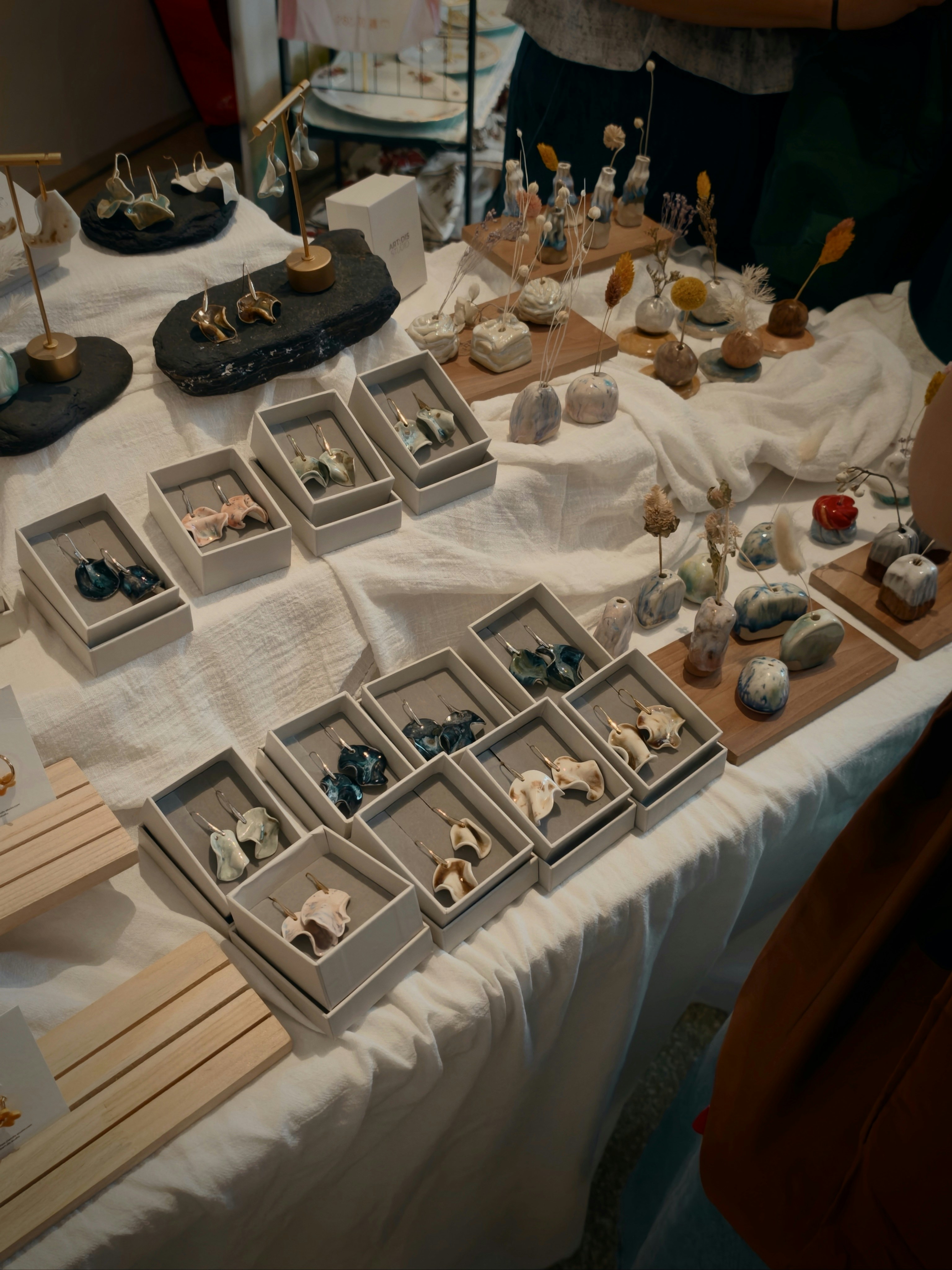Handcrafted Trinkets on Linen: A Jewelry Stall Full of Miniatures