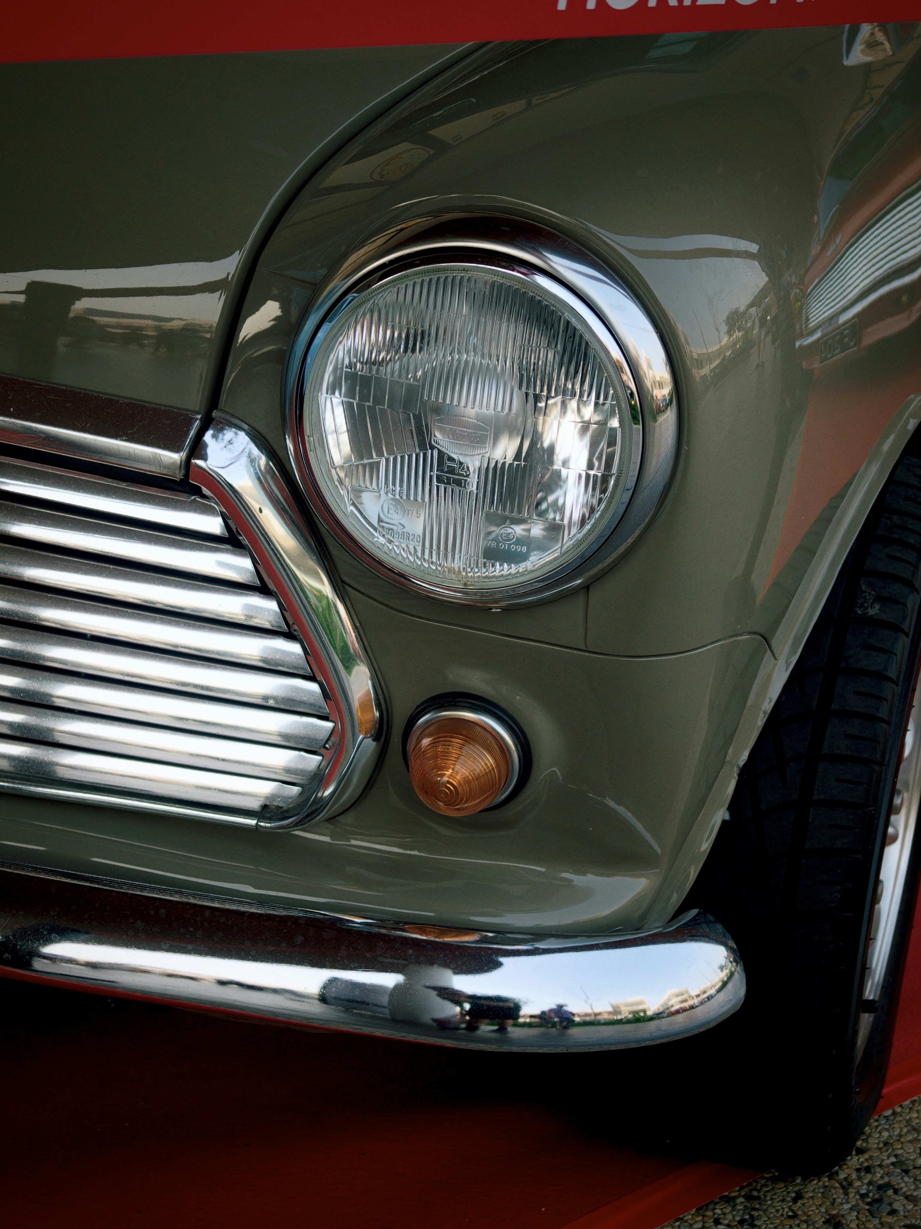 Chrome Grille and Round Headlight on Olive Vintage Car