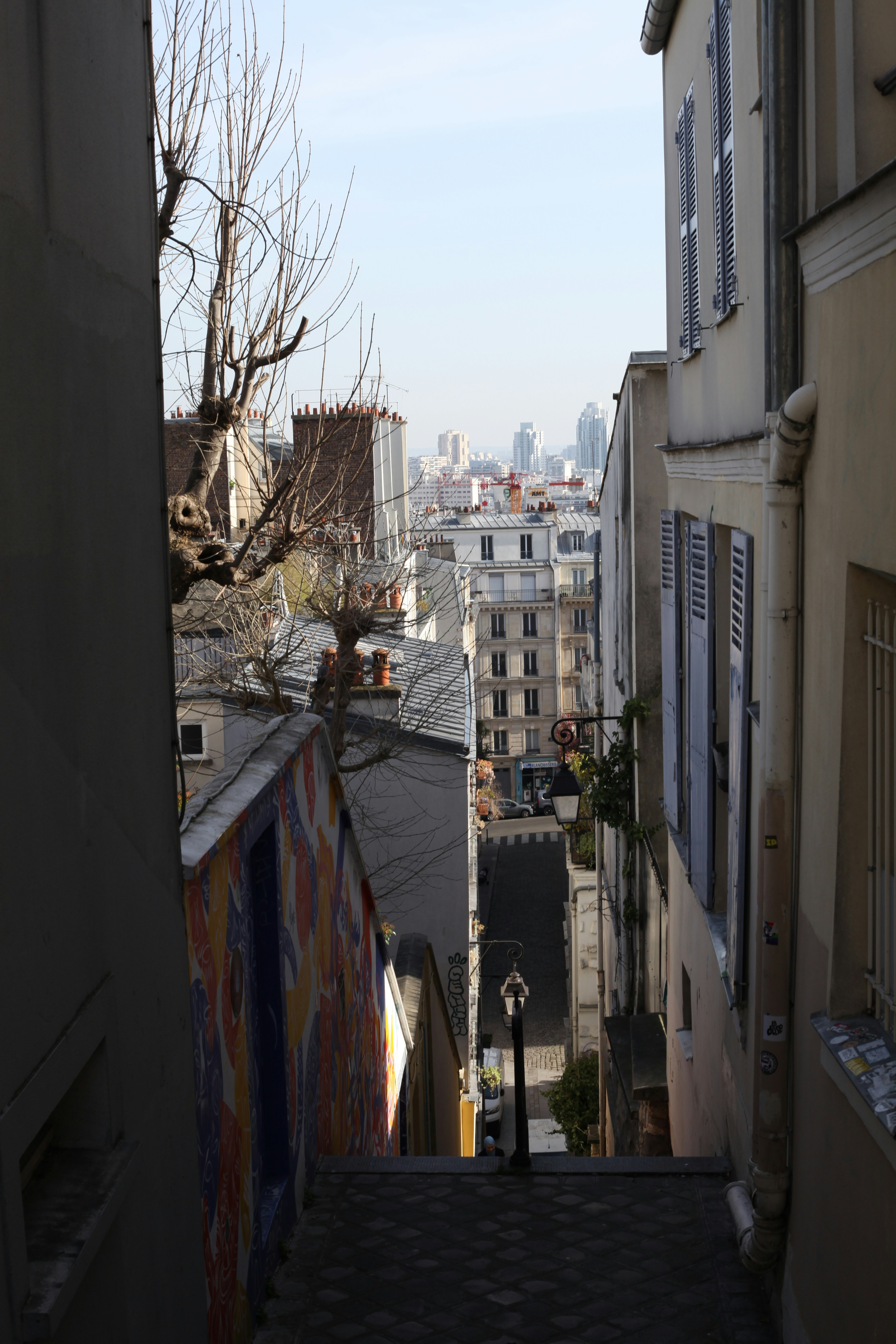A Narrow Staircase to a Distant Cityscape