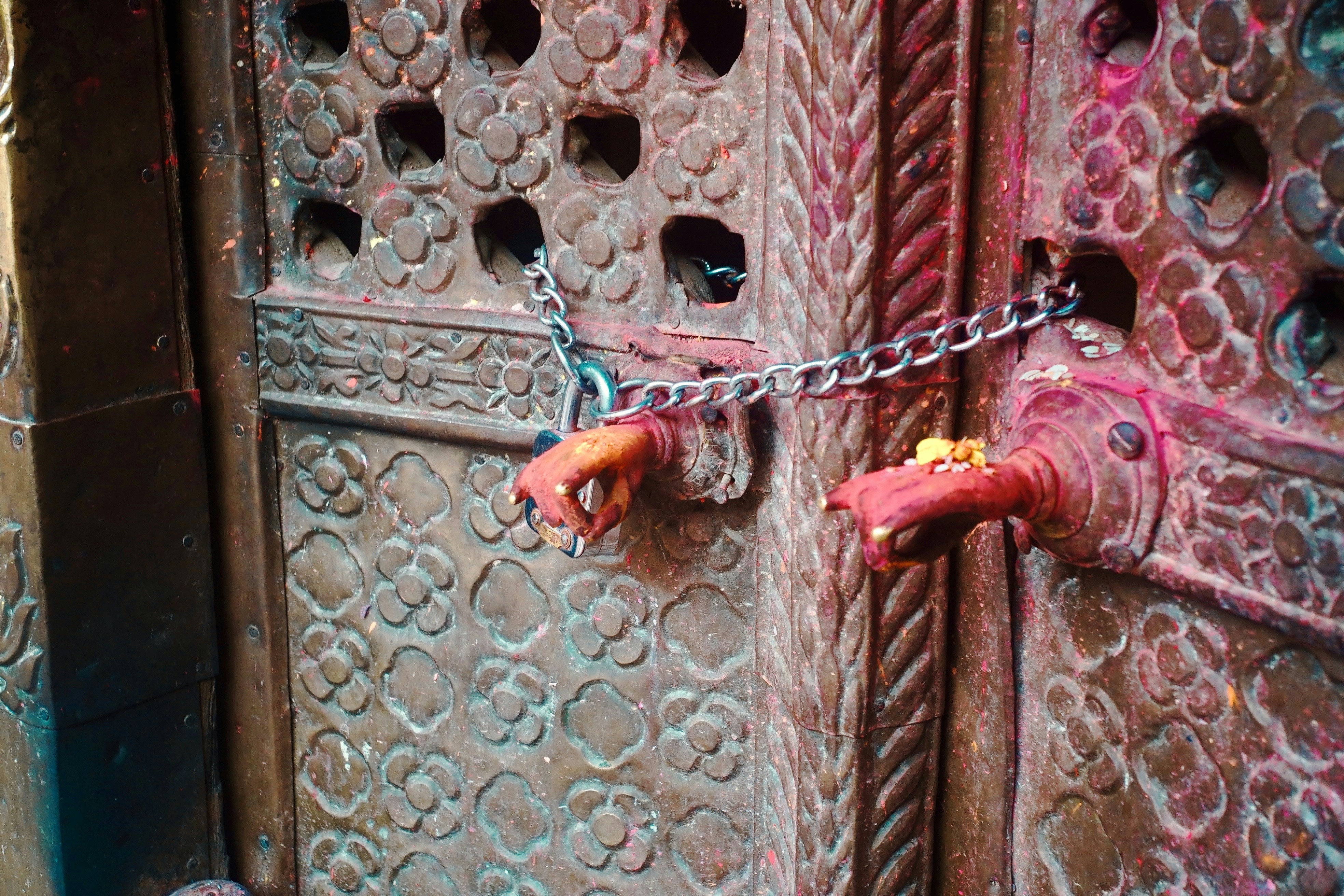 Chains on a Weathered Gate: Ornate Ironwork and Rusted Bolts