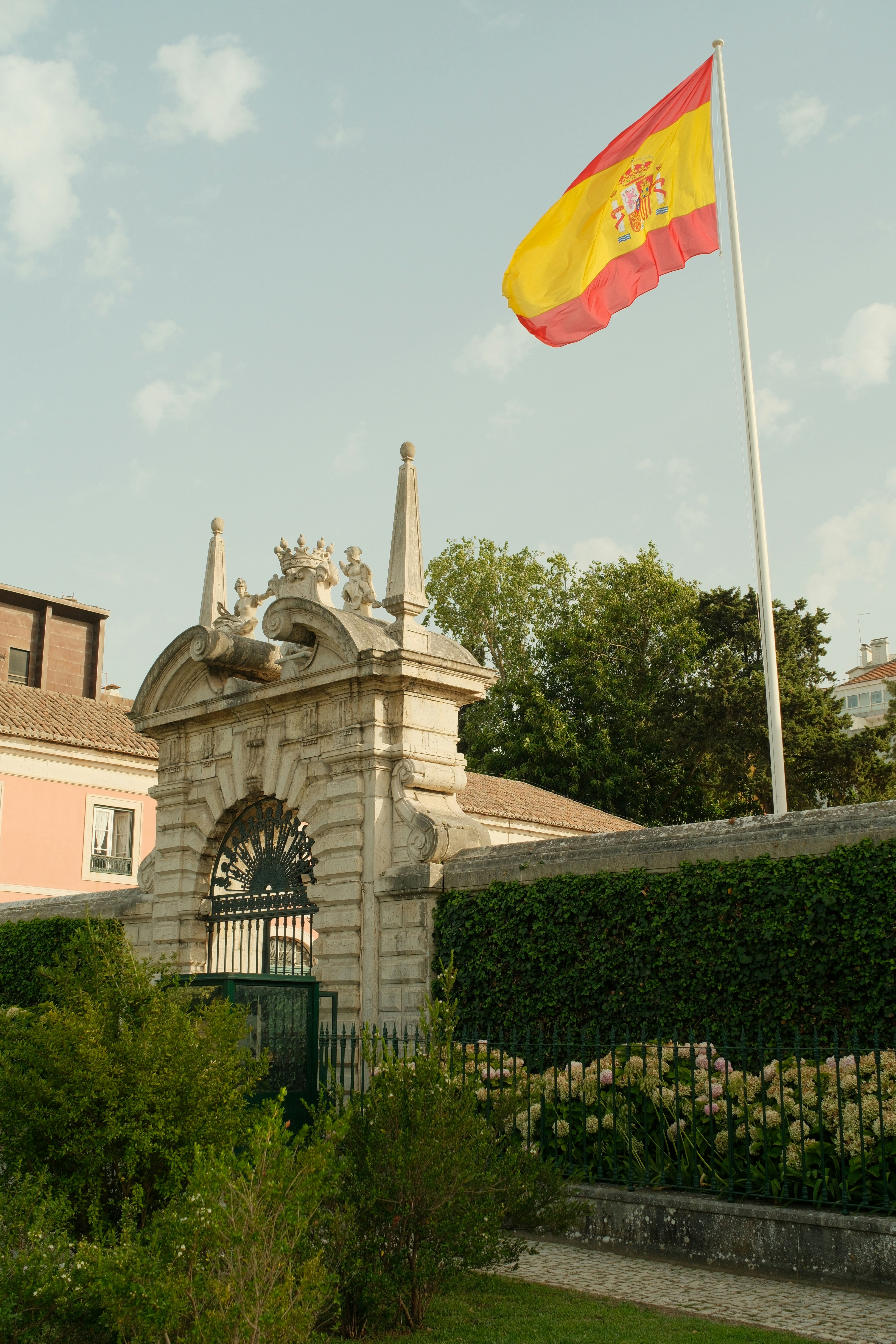 Flag over the Gate: A Spanish Emblem Rising Above Stonework