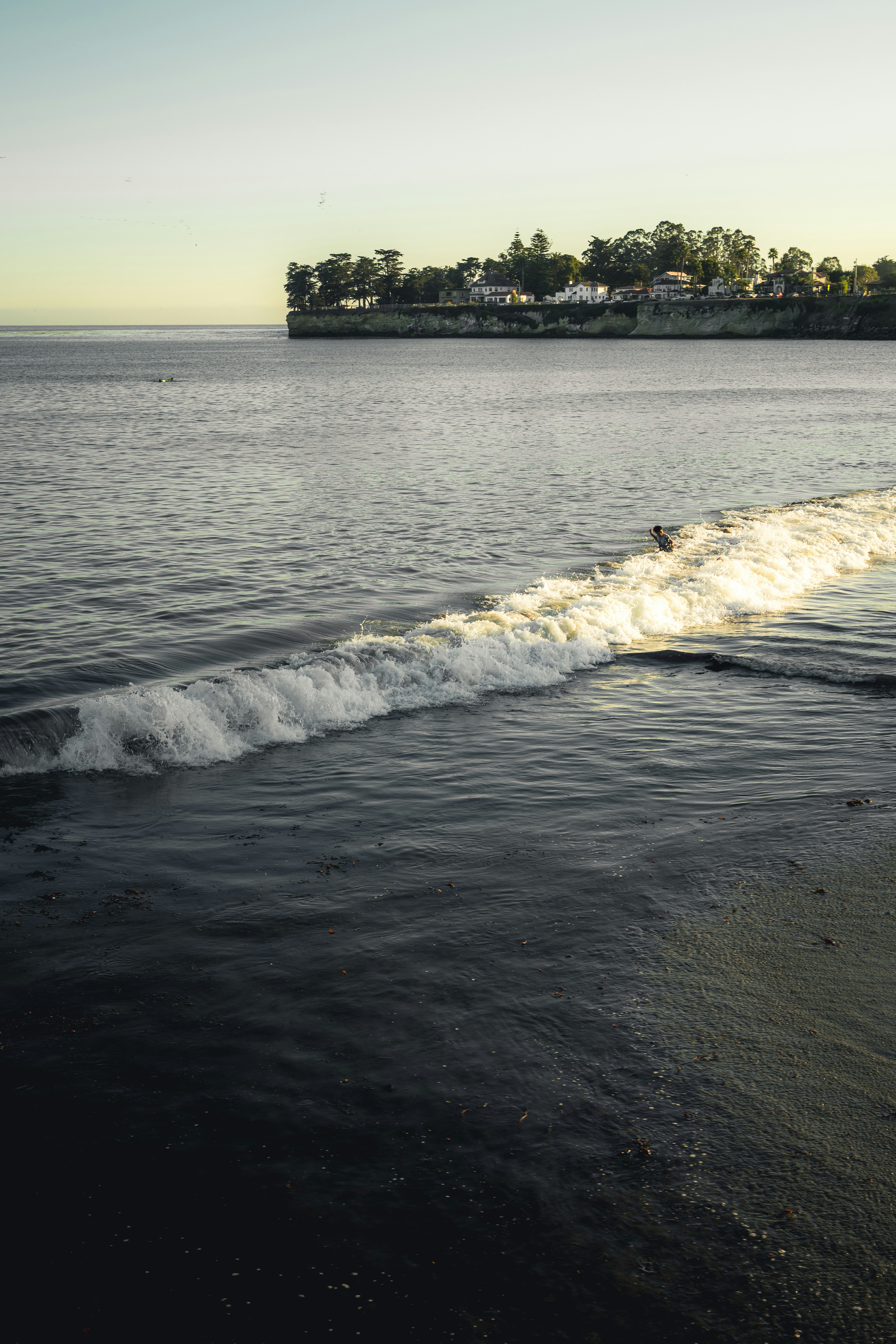 Coastal Crest: A Quiet Surf at the Cliffside Town