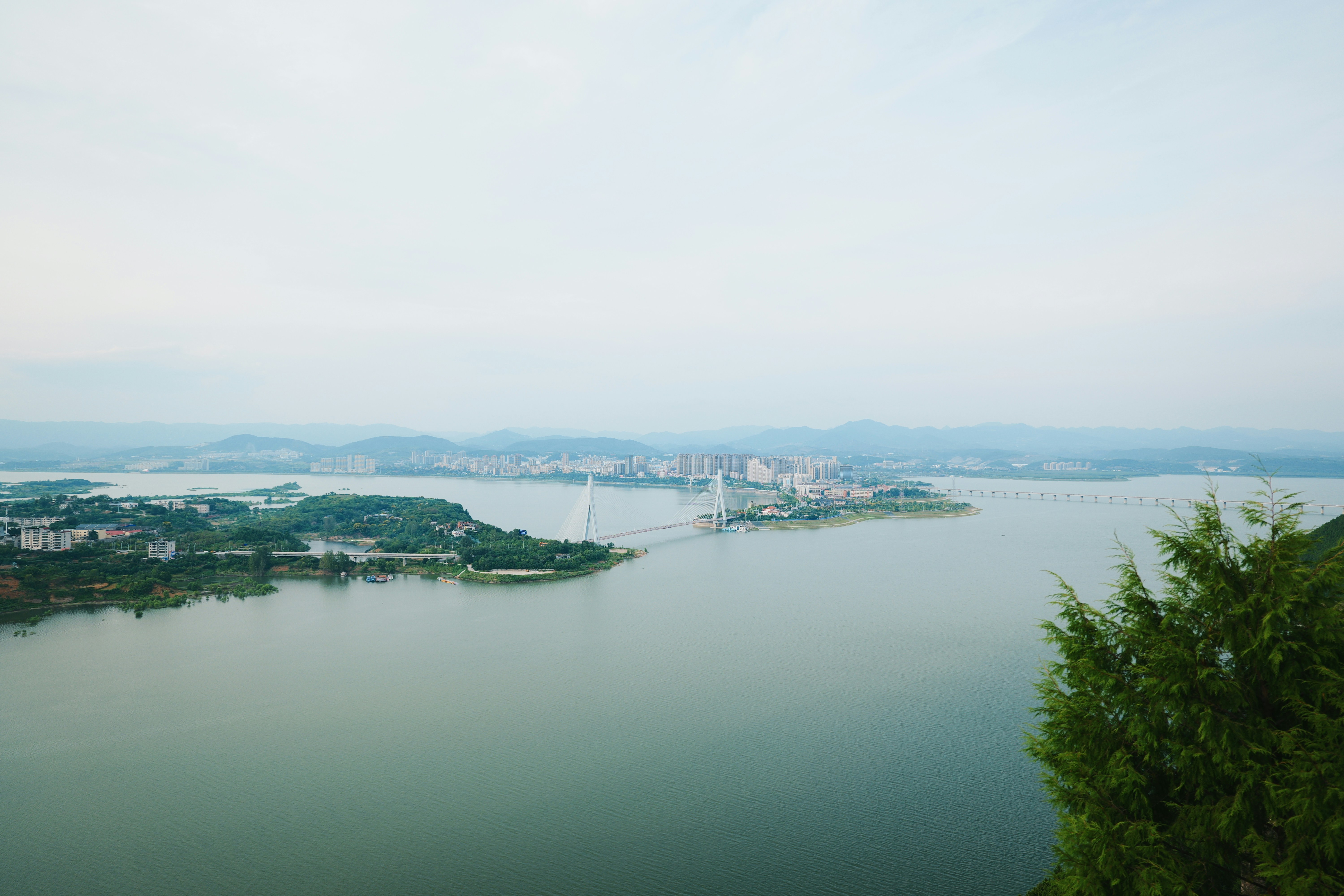 Bridging Waters: A Panoramic Assembly of River and Distant Hills