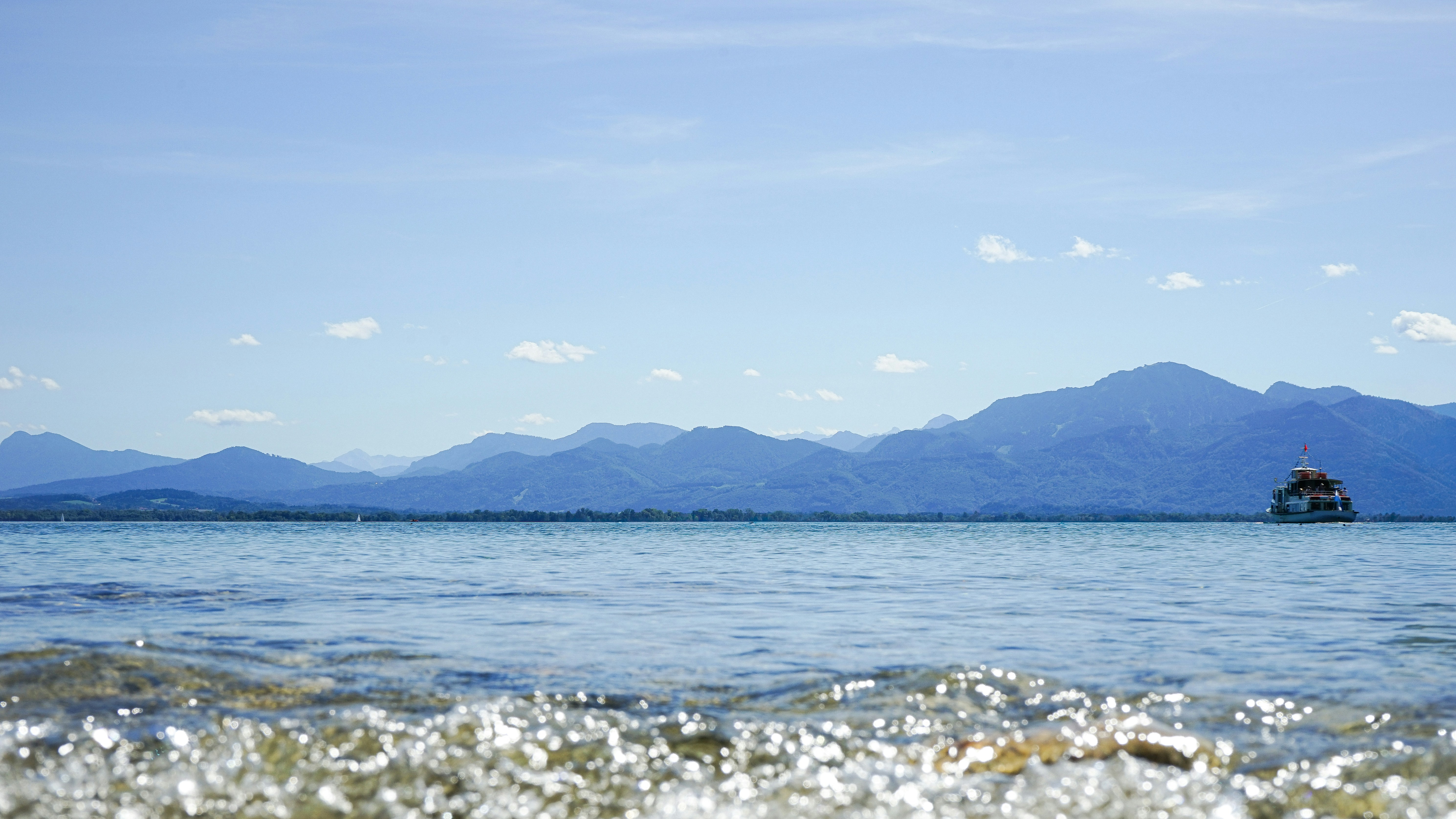 Glacial Blues: Serenity Over the Lake with Distant Peaks