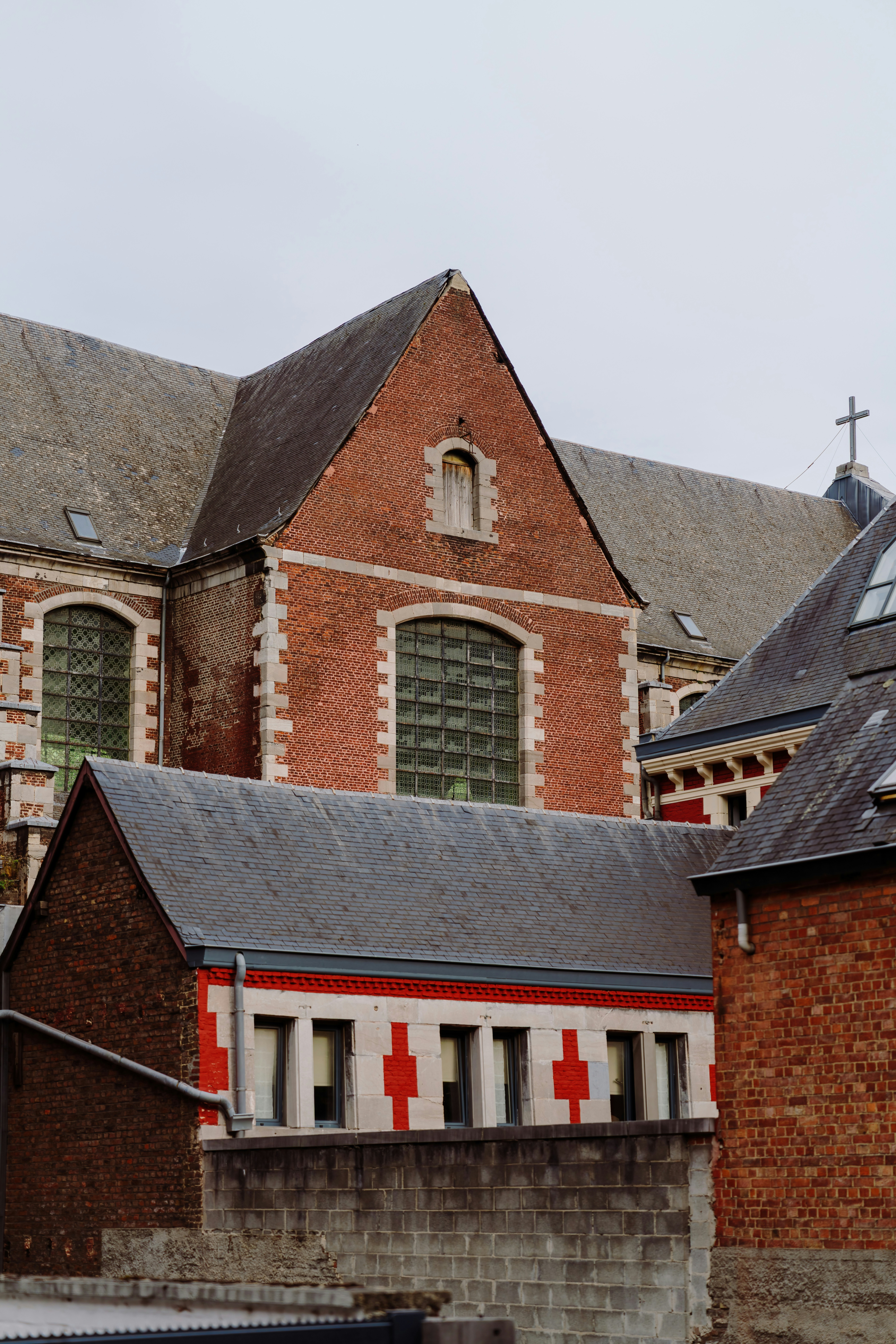 Brick Gothic Ensemble under a Quiet Roofline