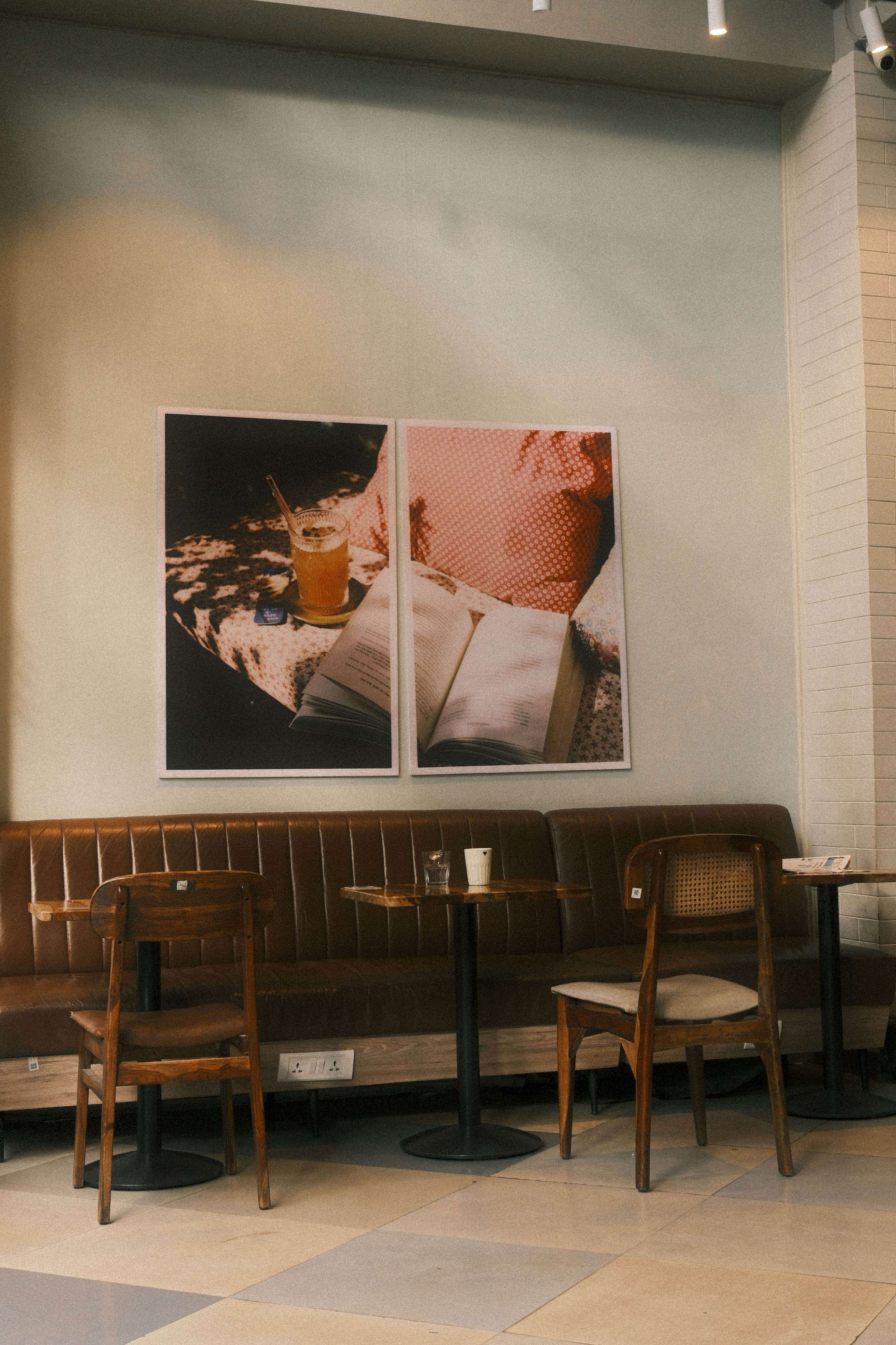 Quiet Corner of a Café: Framed Art and Wooden Tables