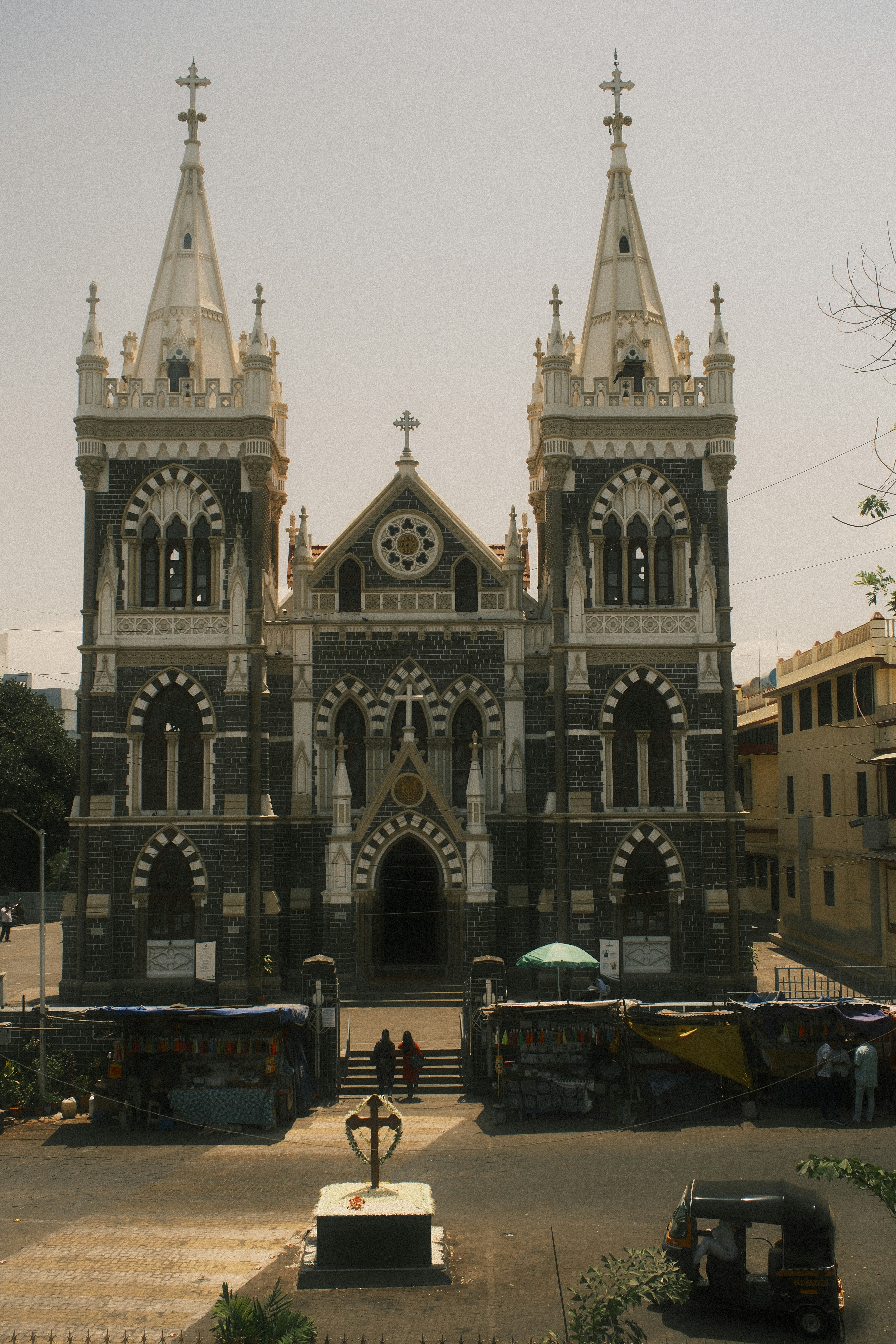 Twin-Spired Basilica: Gothic Facade Rising Over a Busy Market