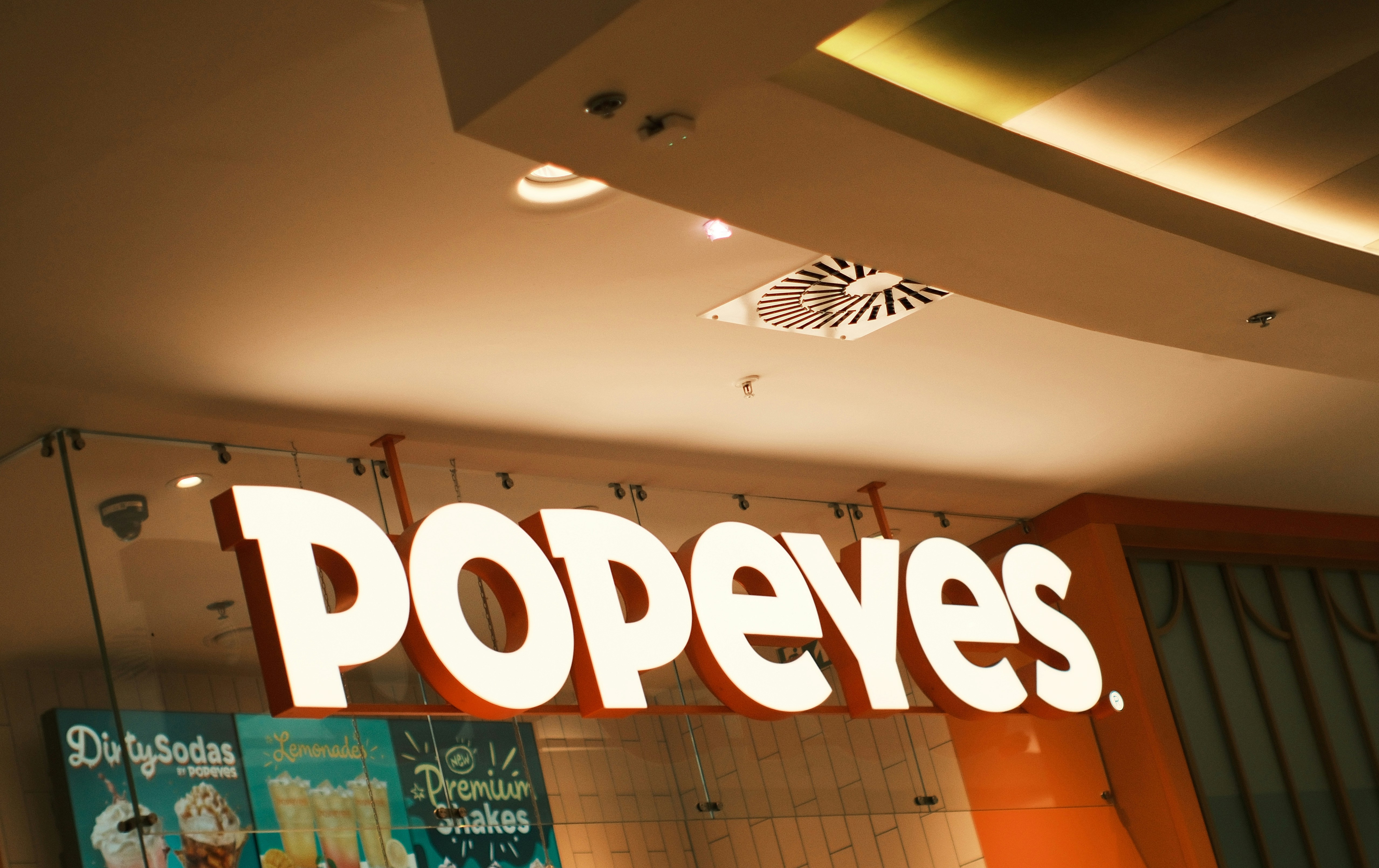 Bold Signage, Warm Interior: A Popeyes Franchise Entrance