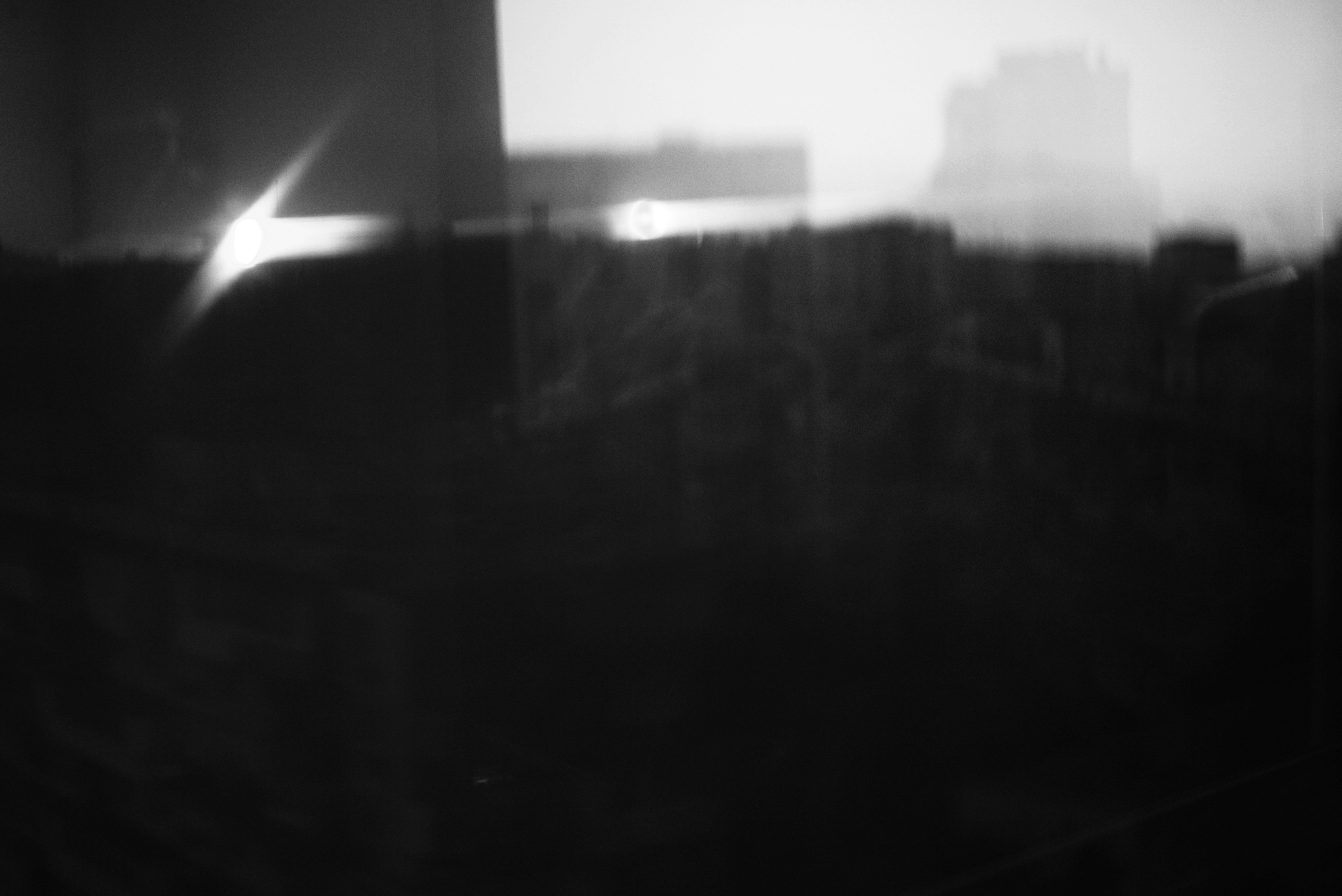 Urban Twilight: Faint Skyline Through Static Glass