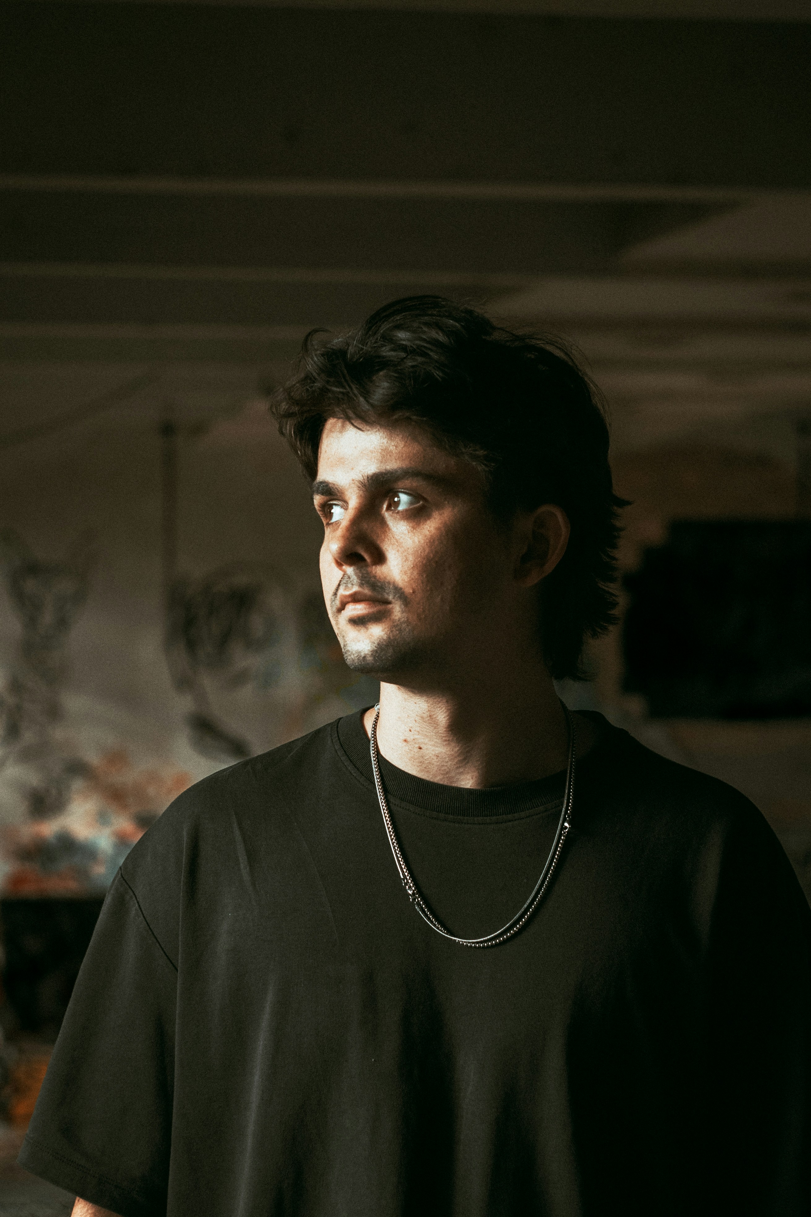 Portrait in Low Light: Contemplation Under Ambient Graffiti