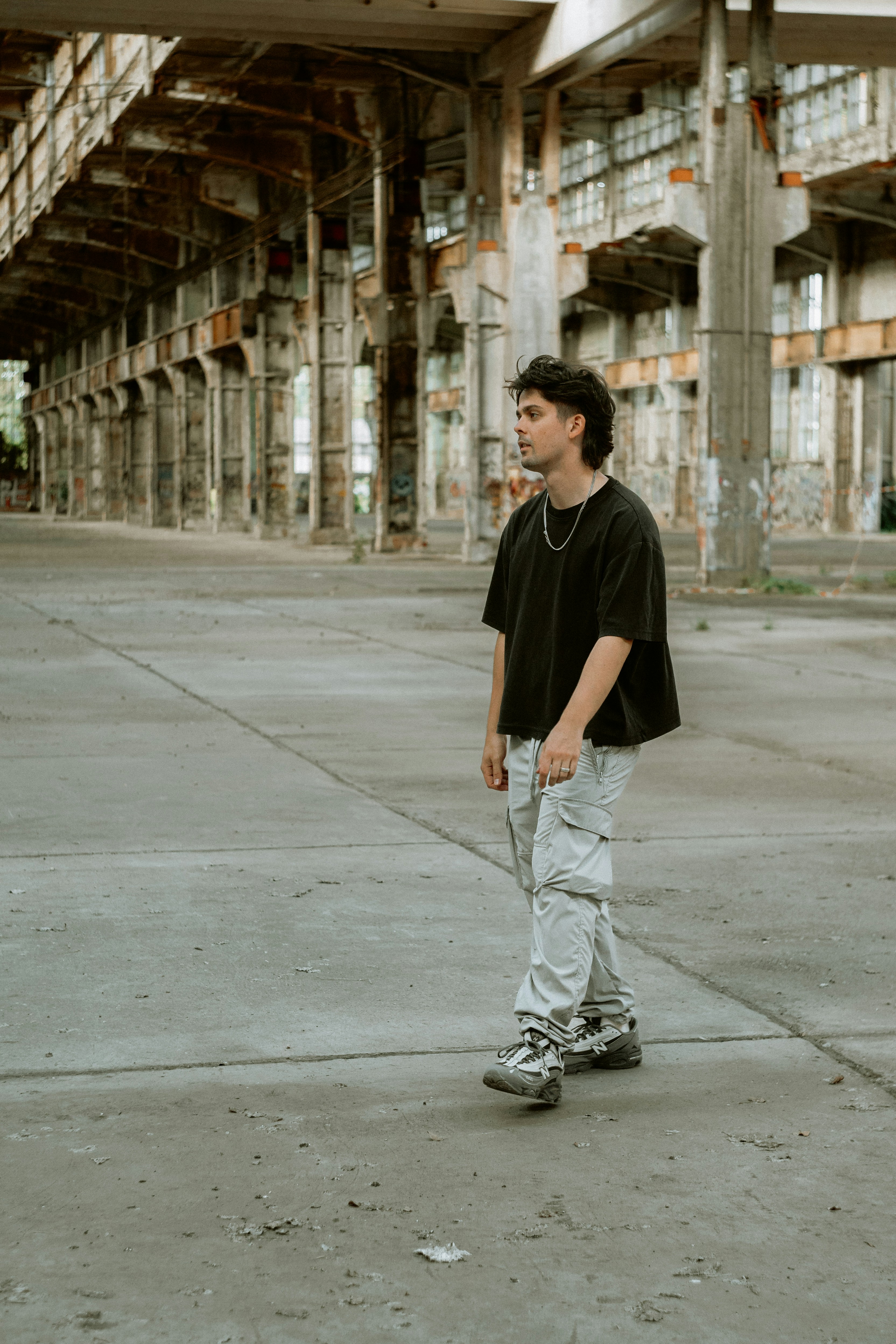 Urban Wanderer in a Ghost-Site: A Youthful Pause Among Concrete Columns