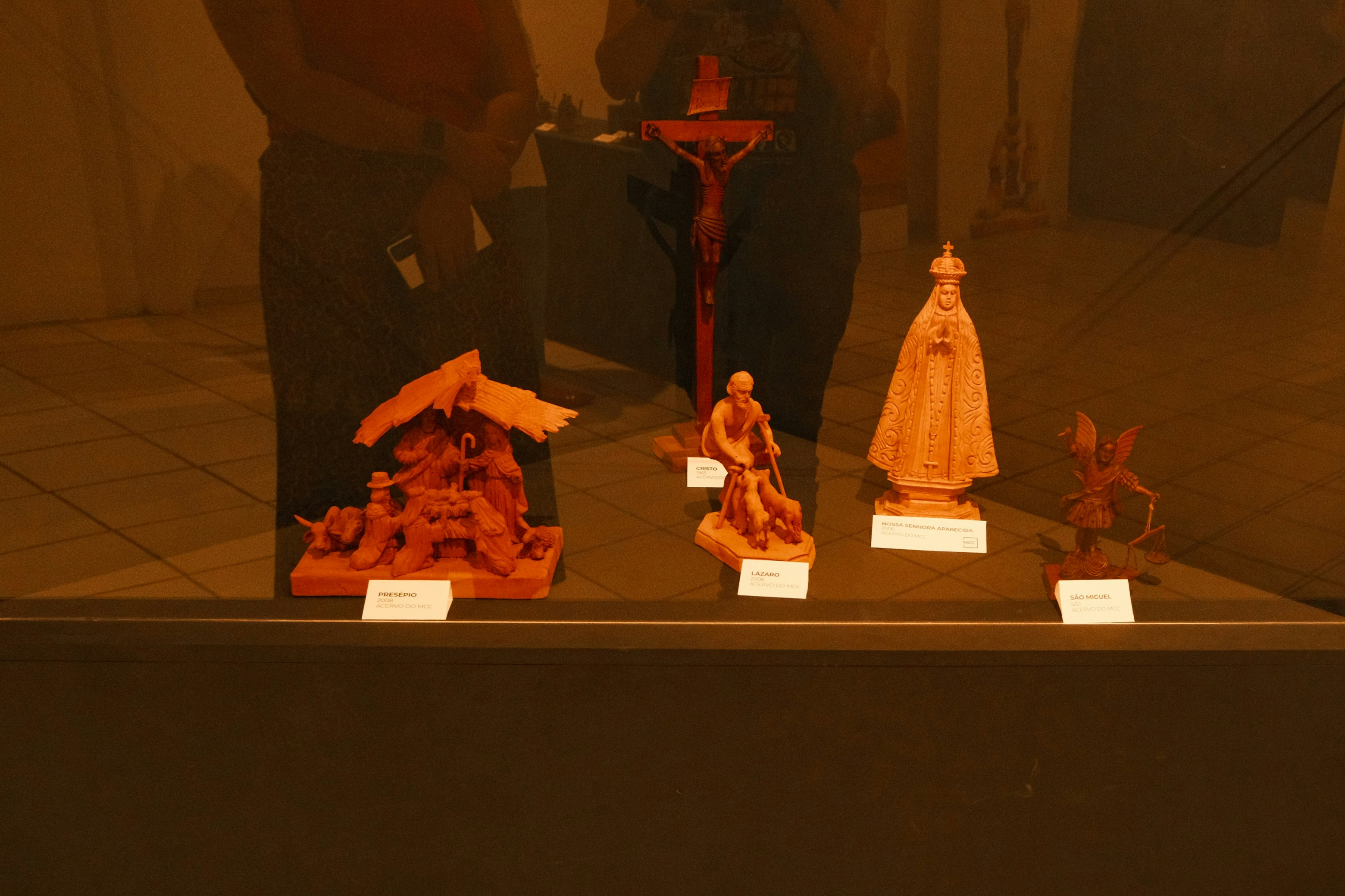 Miniature Cathedral Choir: A Row of Figurines in a Glass Case
