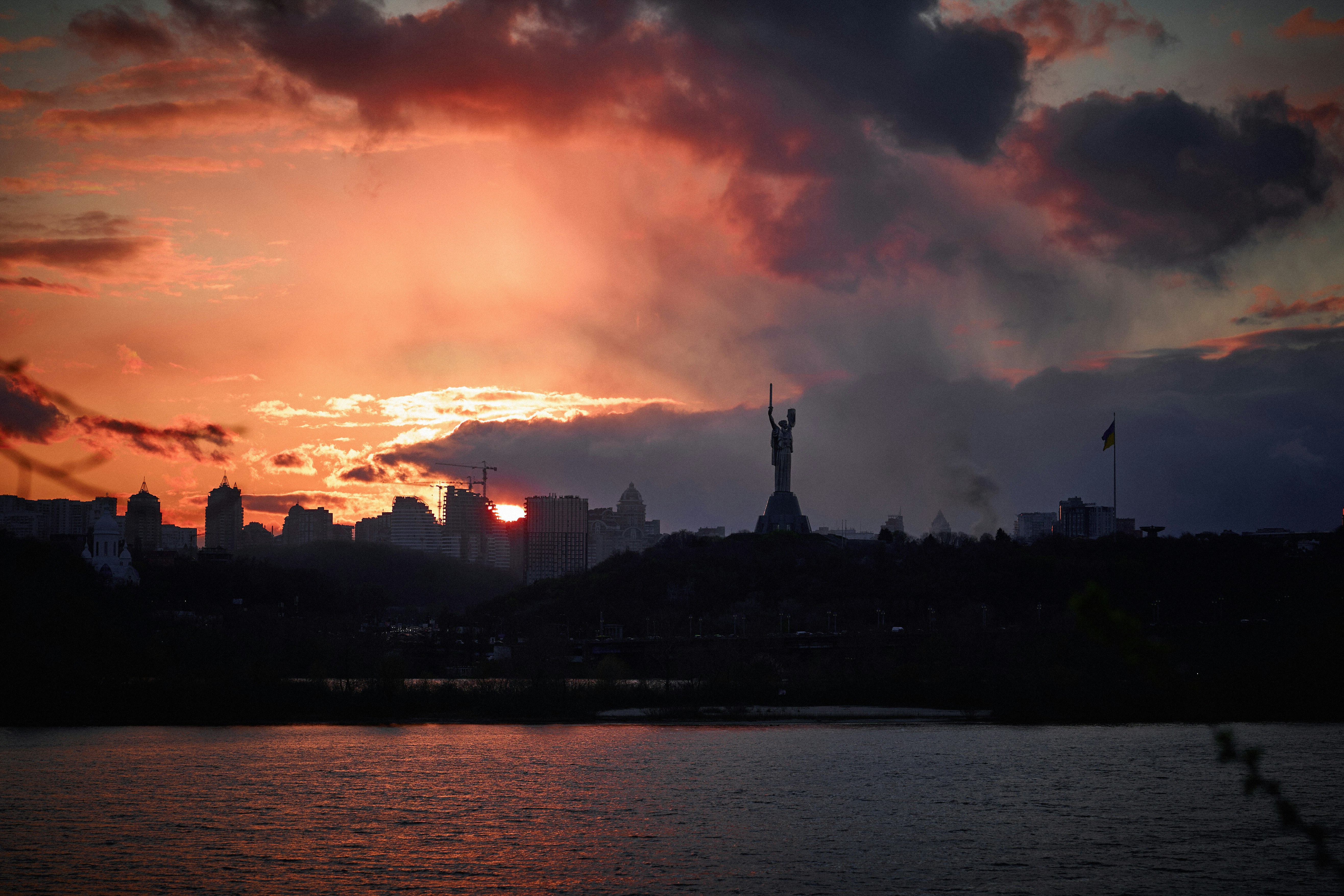 Dusk Over the Harbor: Silhouette of a City Horizon Beneath a Fiery Sky
