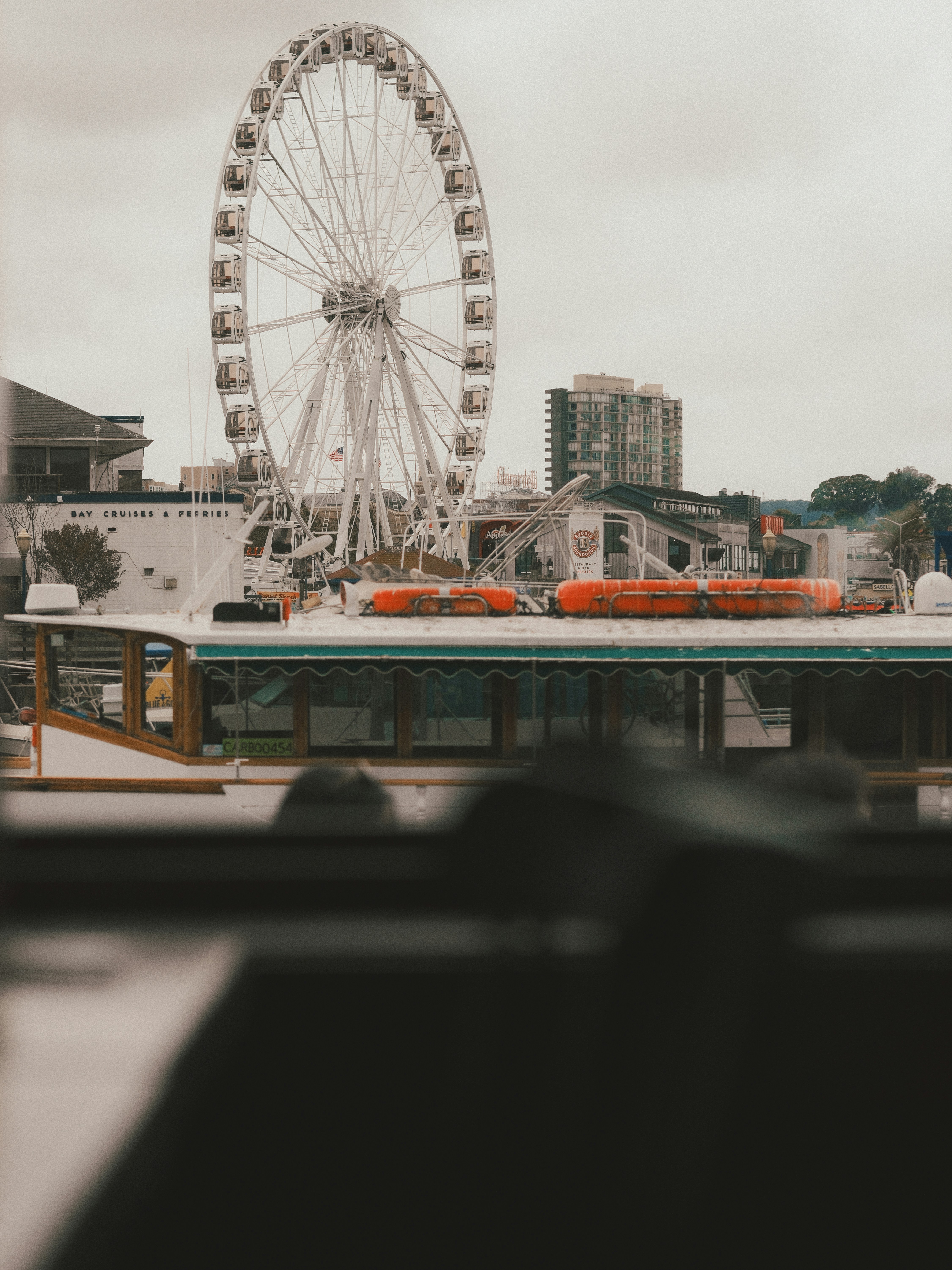 Ferris Wheel Silhouette over a City Waterfront