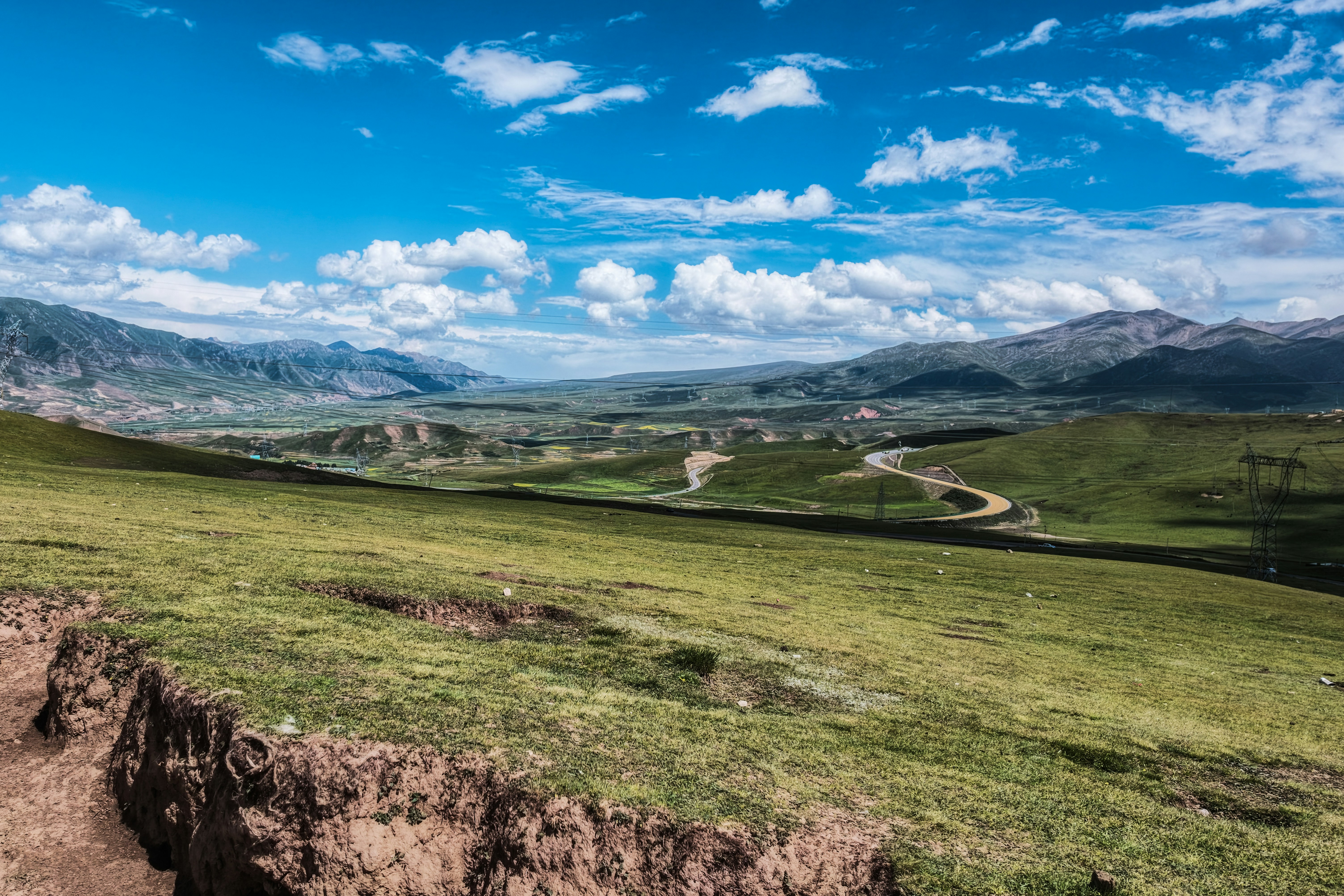 Rolling Hills and Winding Road: A Quiet Alpine Panorama