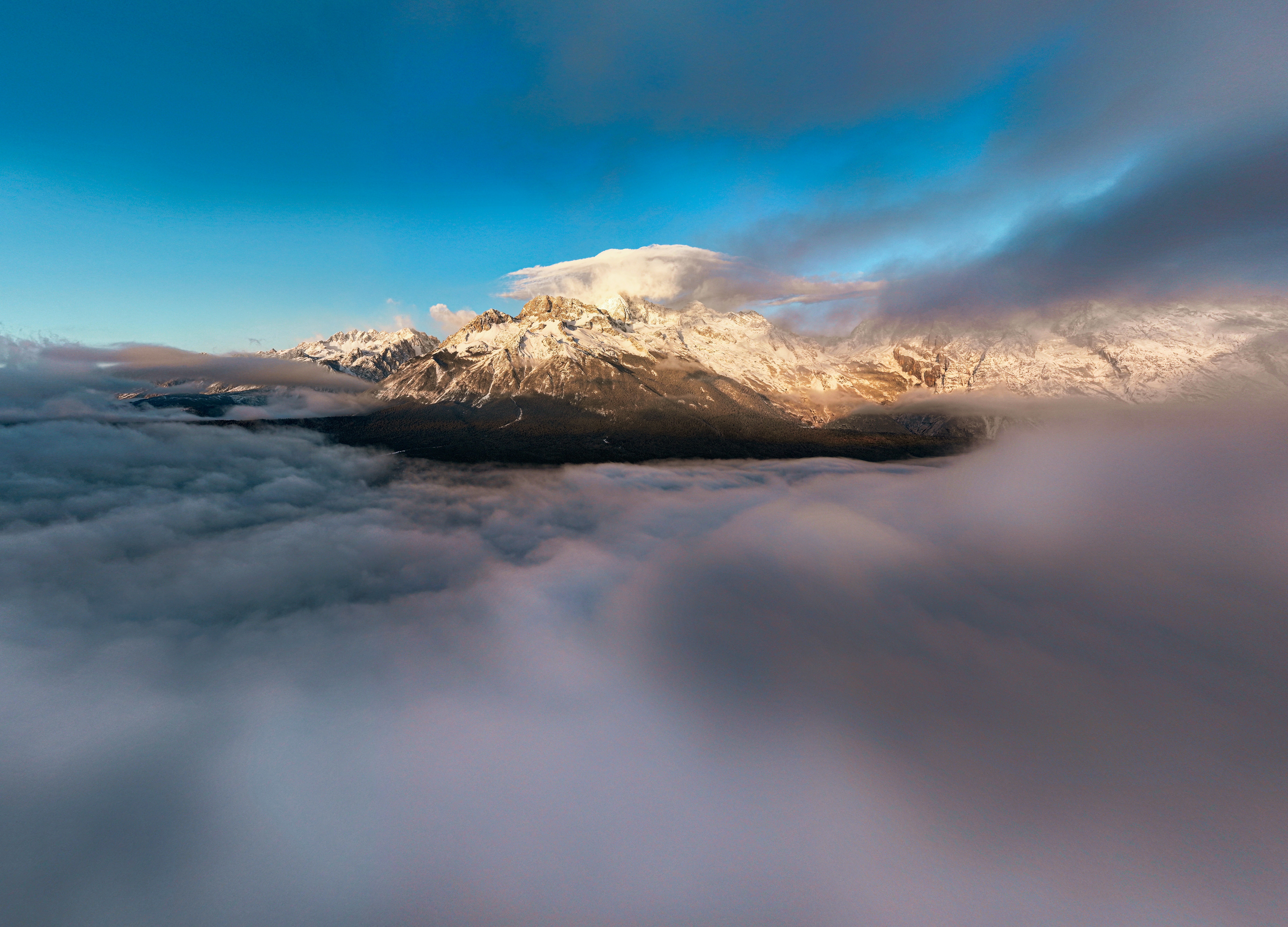 Snow-Crowned Summit Pierced by Alpine Light