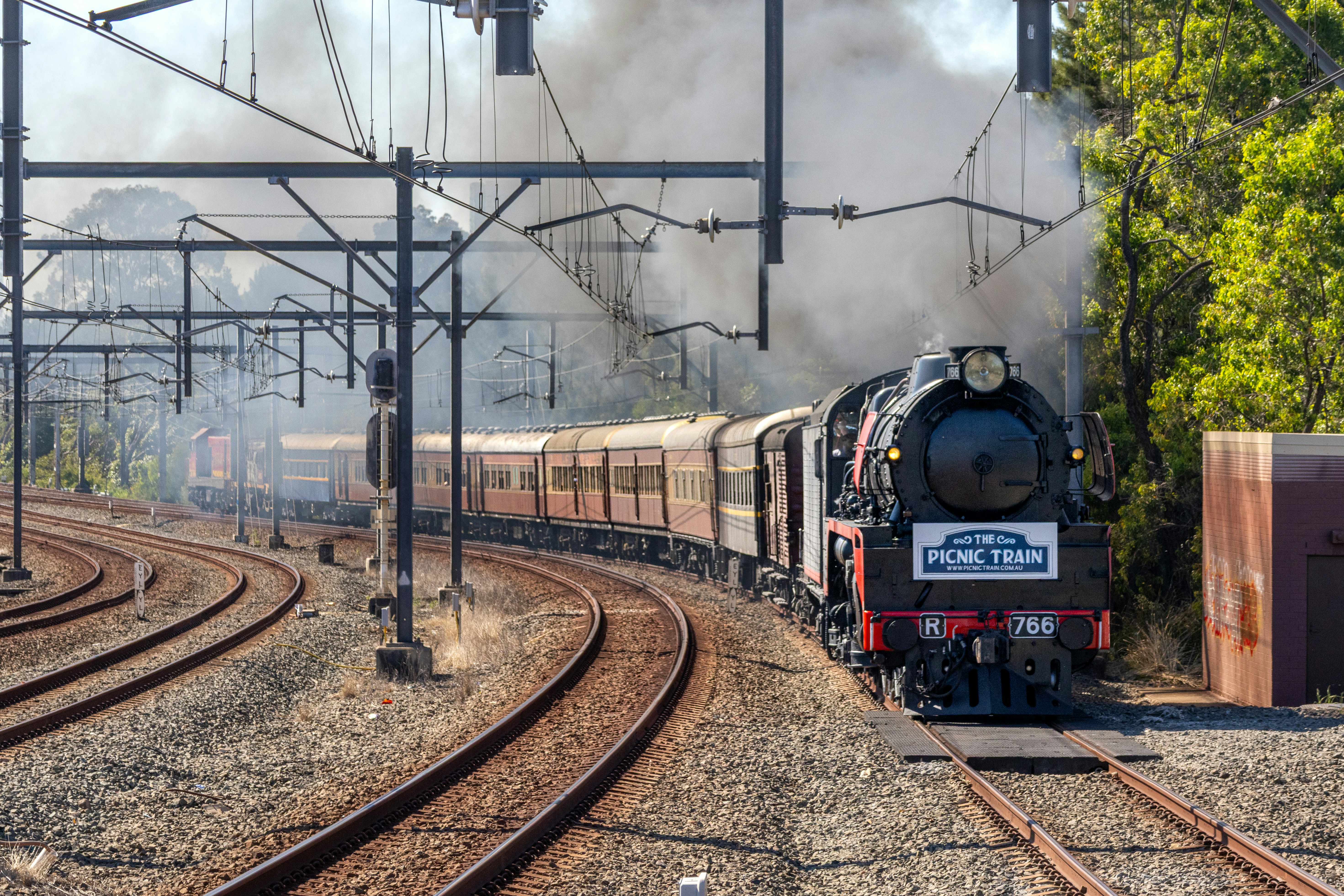 Steam Lined Track: A Heritage Express Surges Through Smoke and Steel