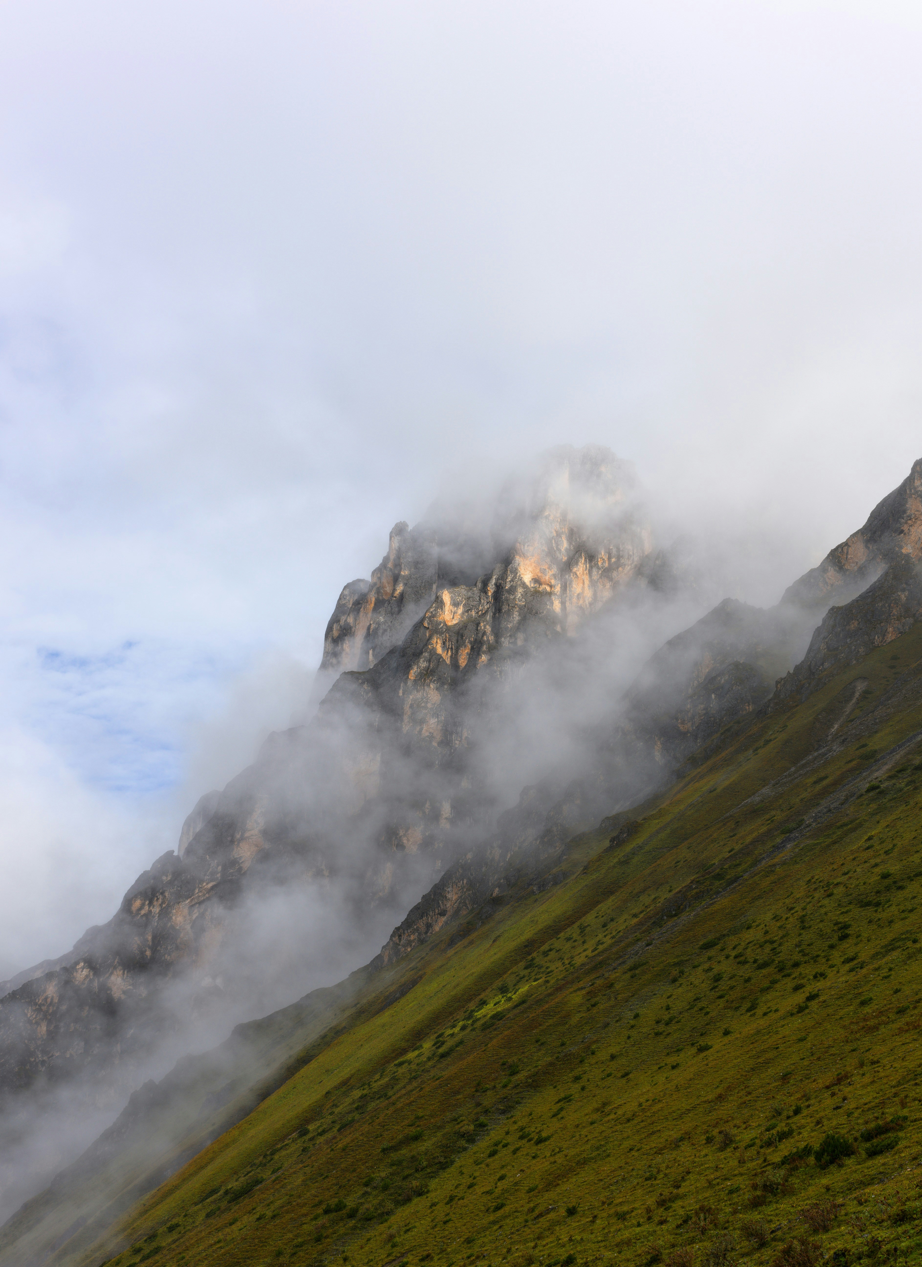 Ridge Amid the Clouds: A Mountain Peak Emerging from Mist