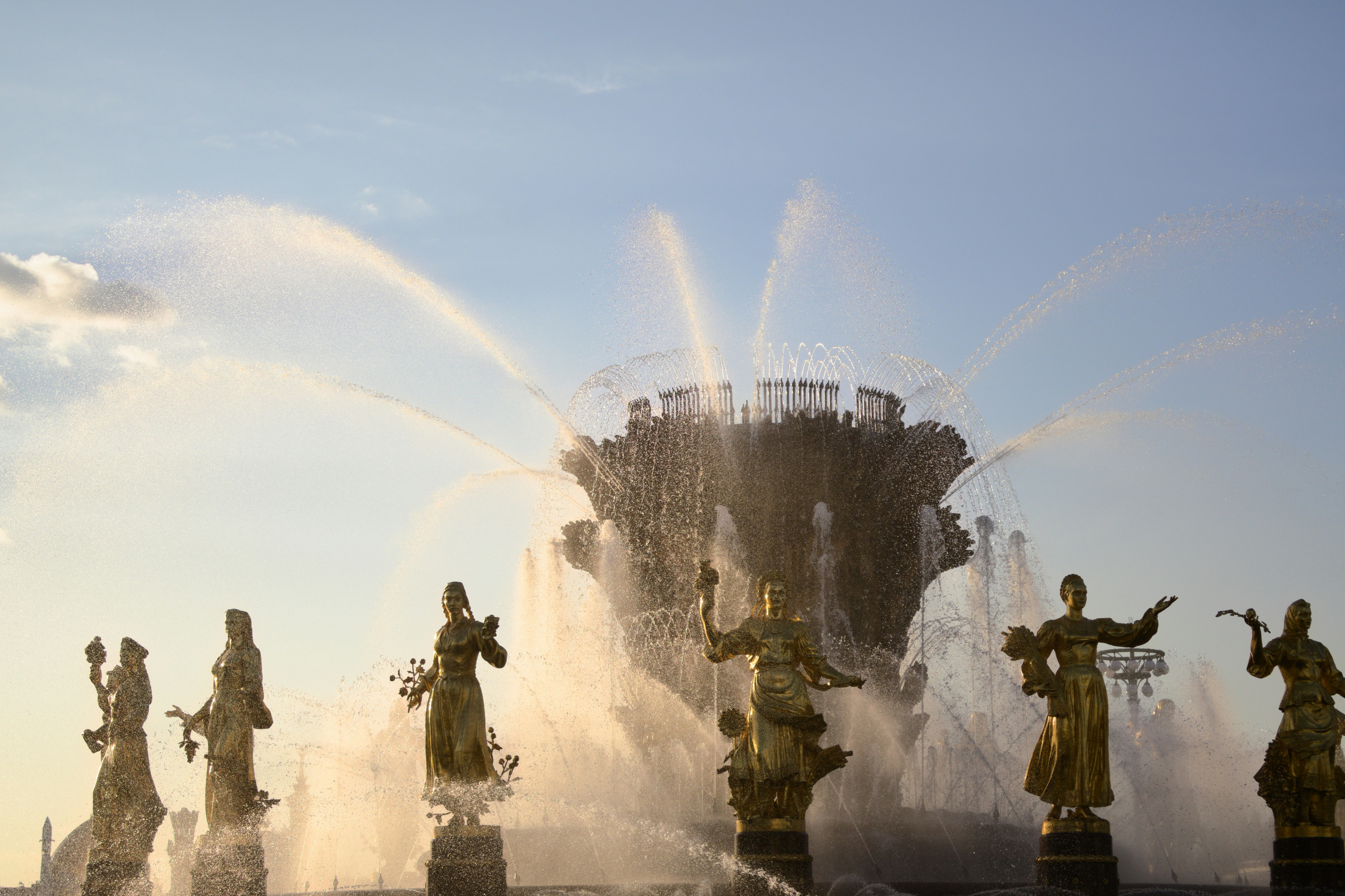 Water arcs over gilded statues: the grand fountain at golden hour