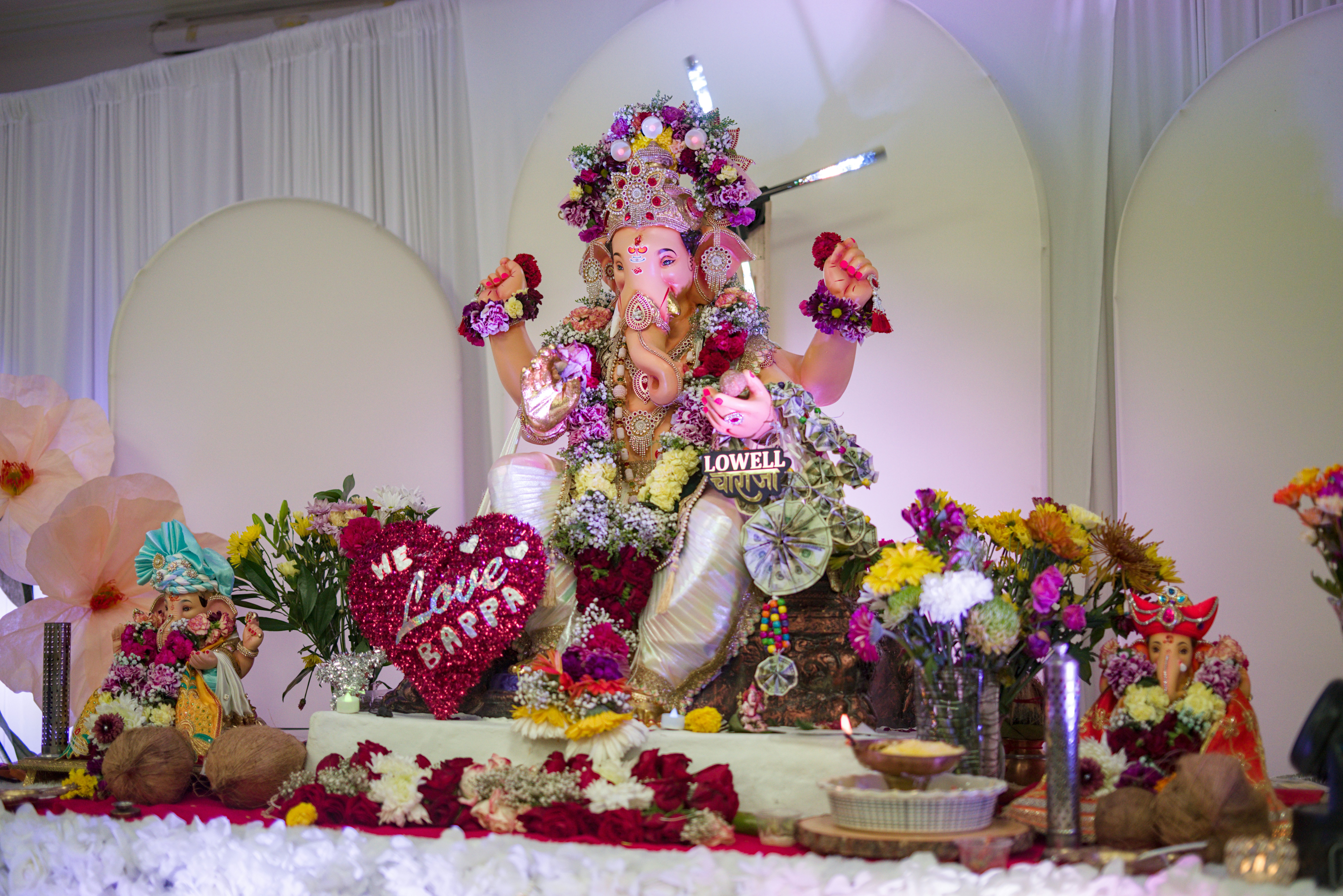 Floral Ganesh Altar: A Budding Shrine Amid Colorful Offerings