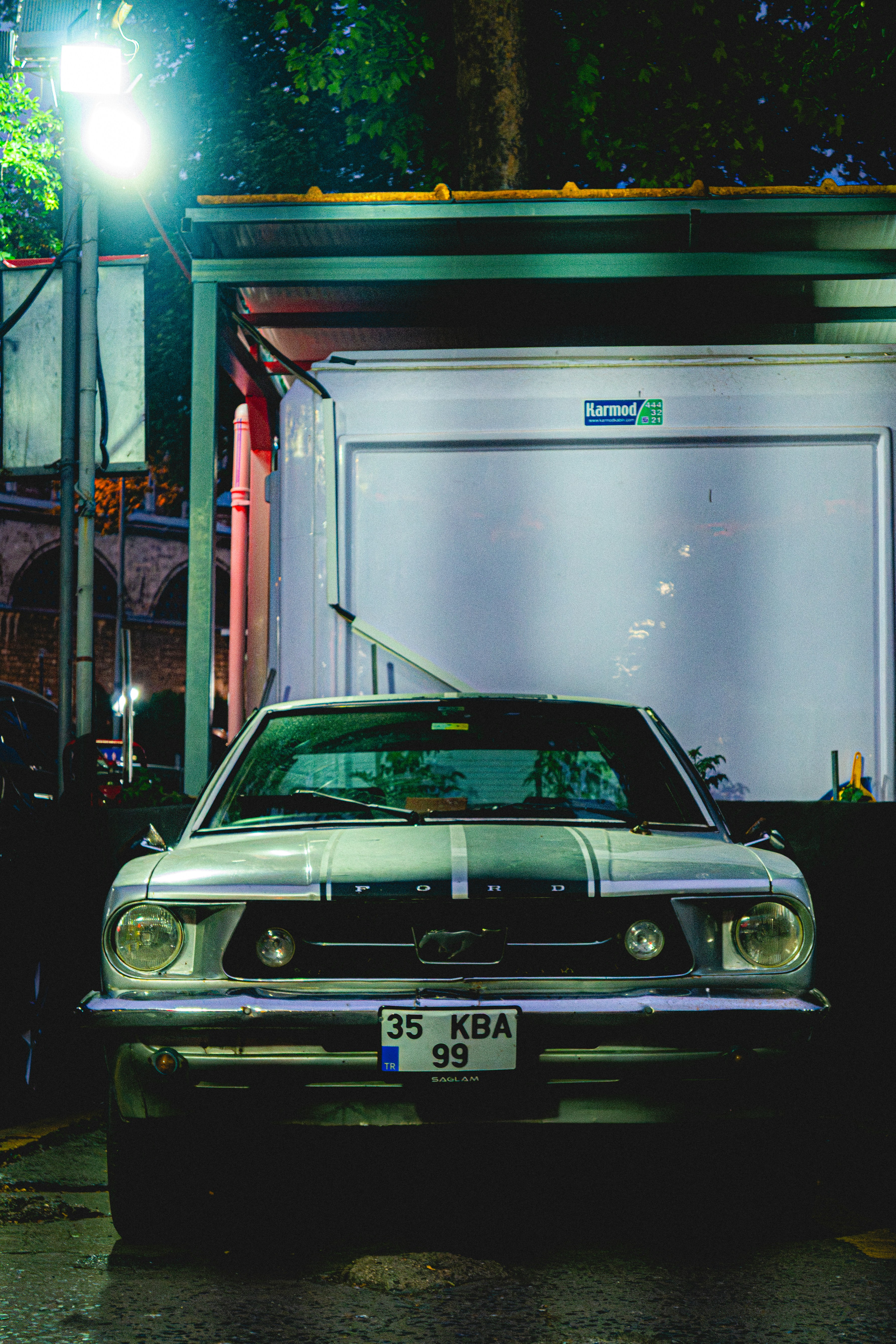 Stalled Night: A Classic Car Under Neon Vigil