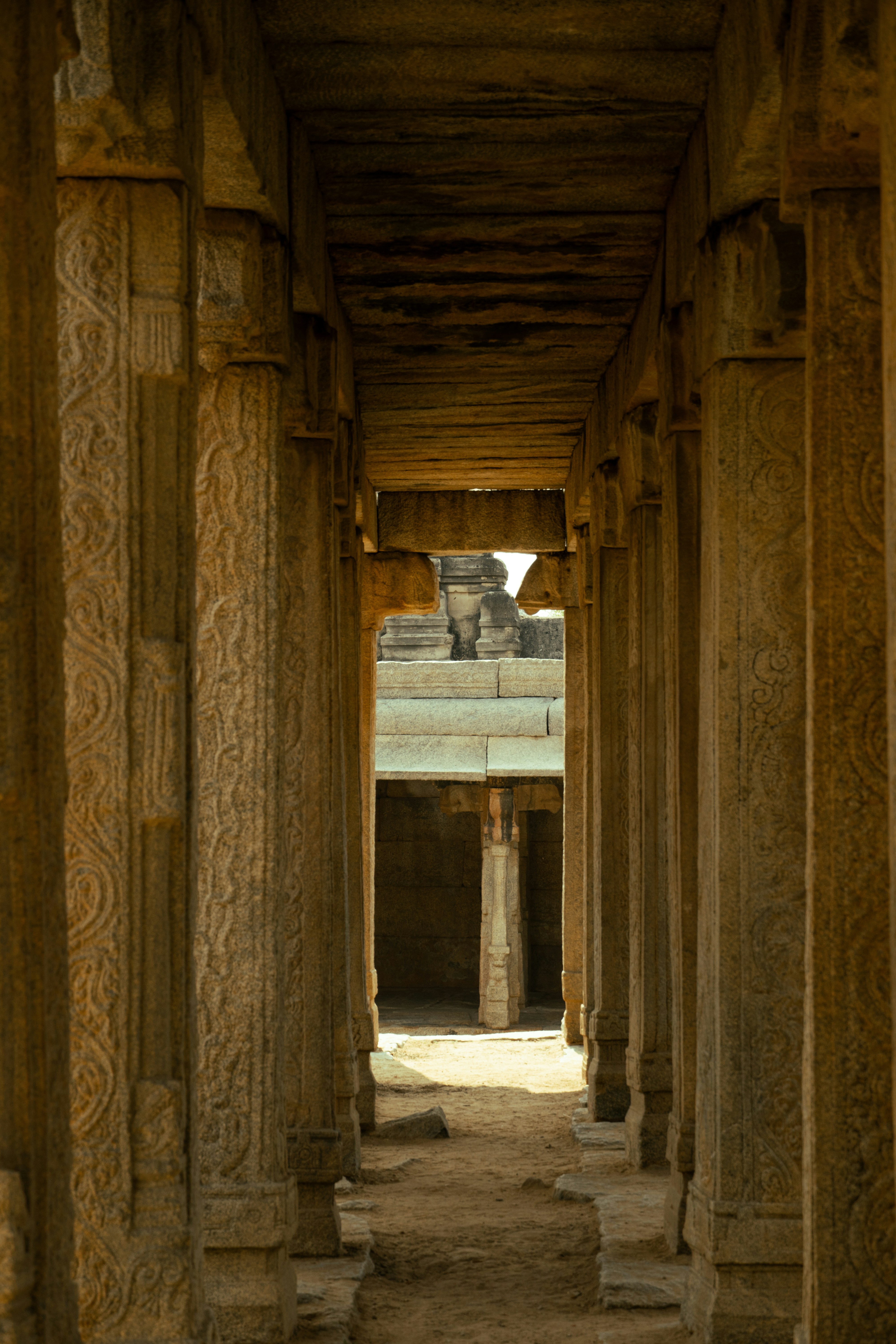 Sunlit Corridor of Carved Columns: Echoes Through an Ancient Temple