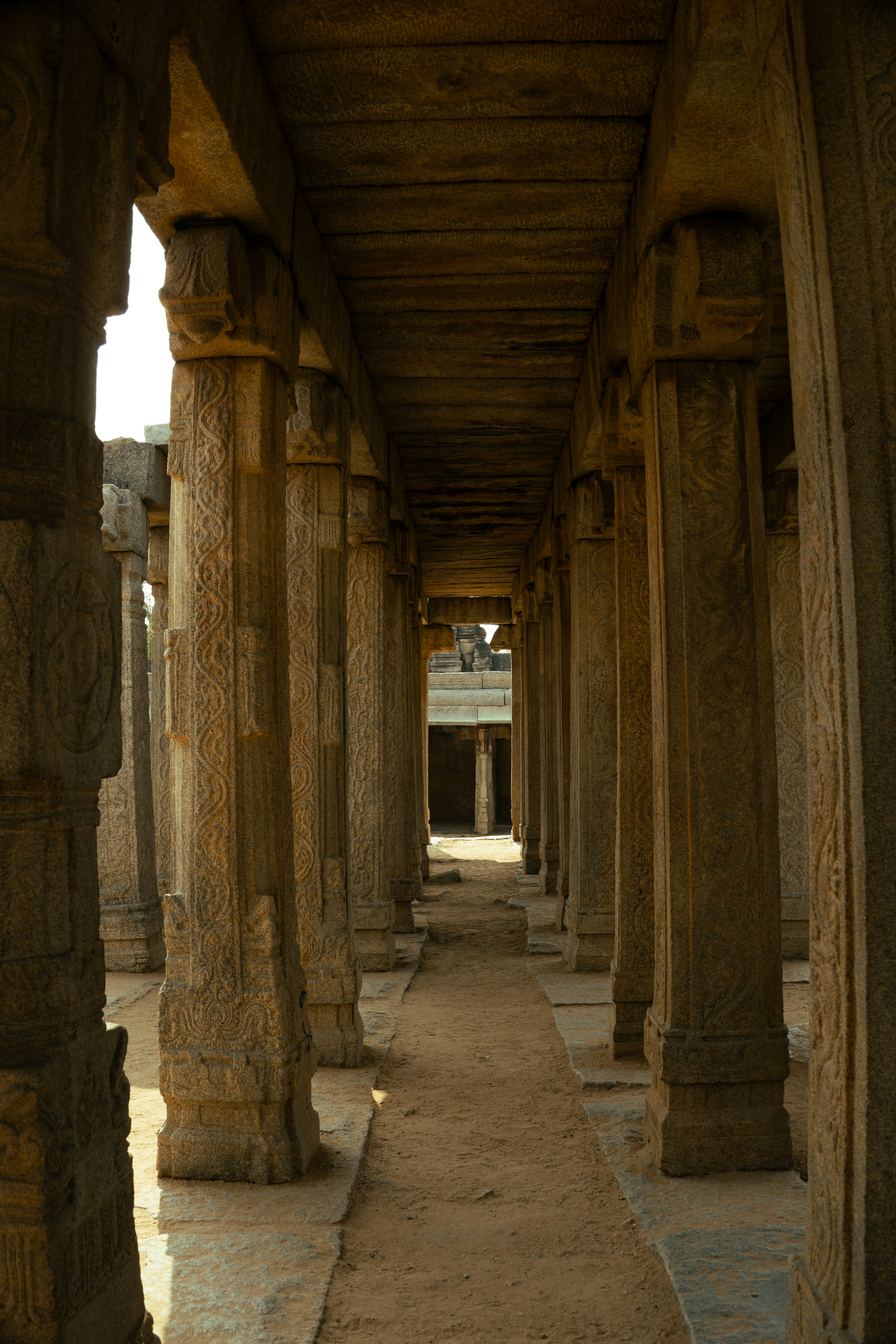 Amber Corridor: Stone Columns Leading Toward Light