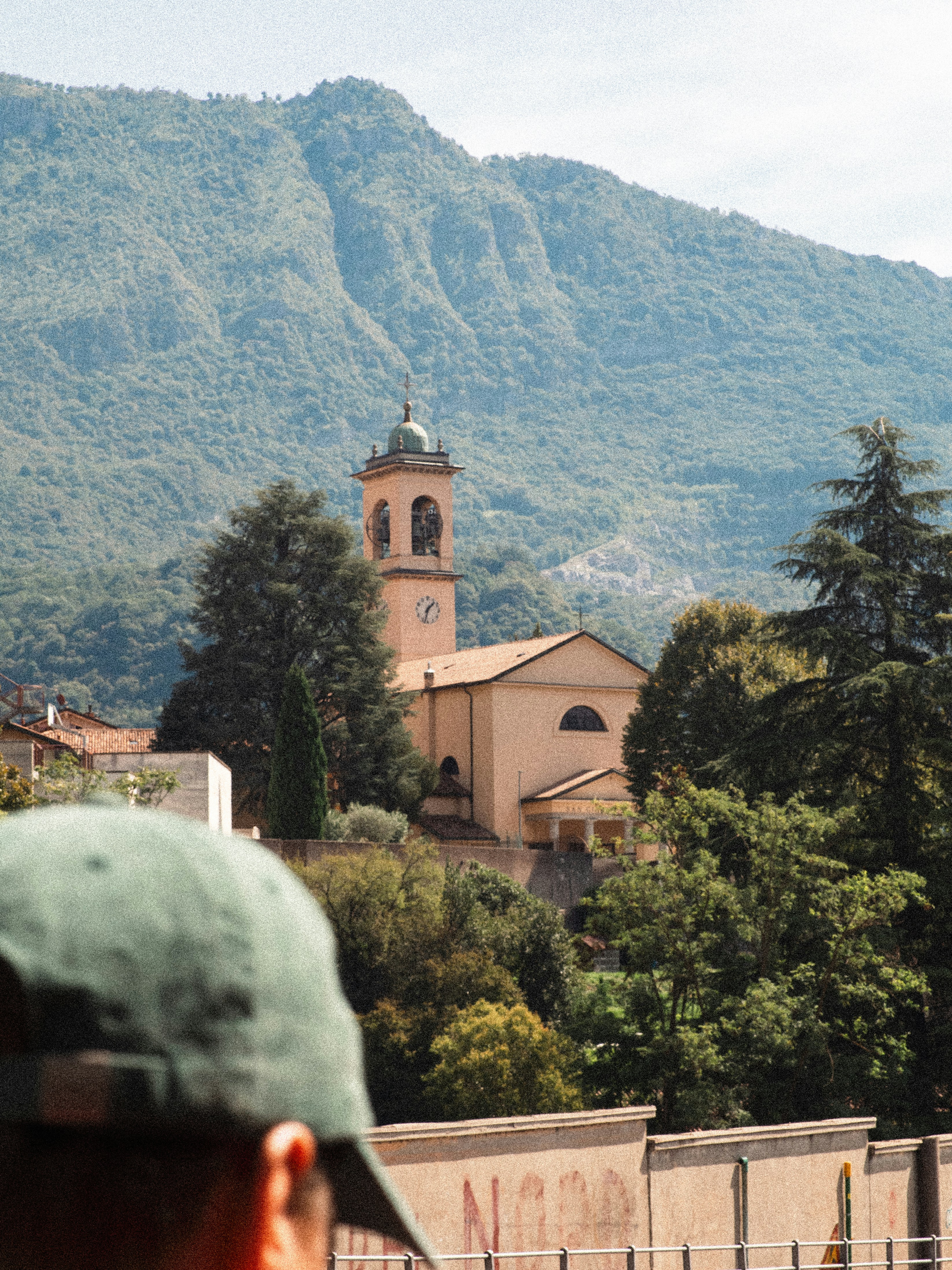 Village Bell Tower Rising Above the Green Hills