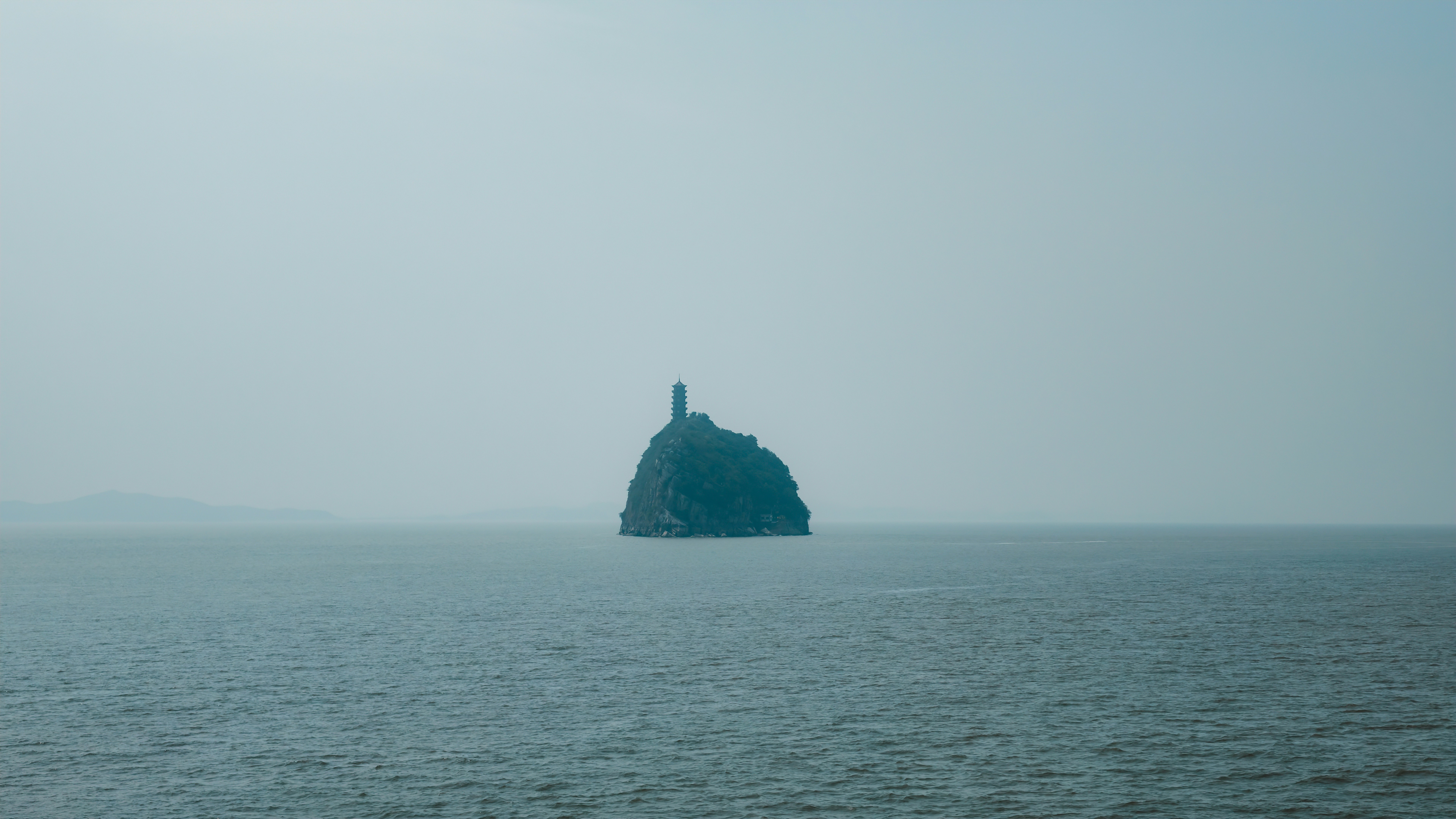  solitary sea‑island with a lone tower rising from the rock