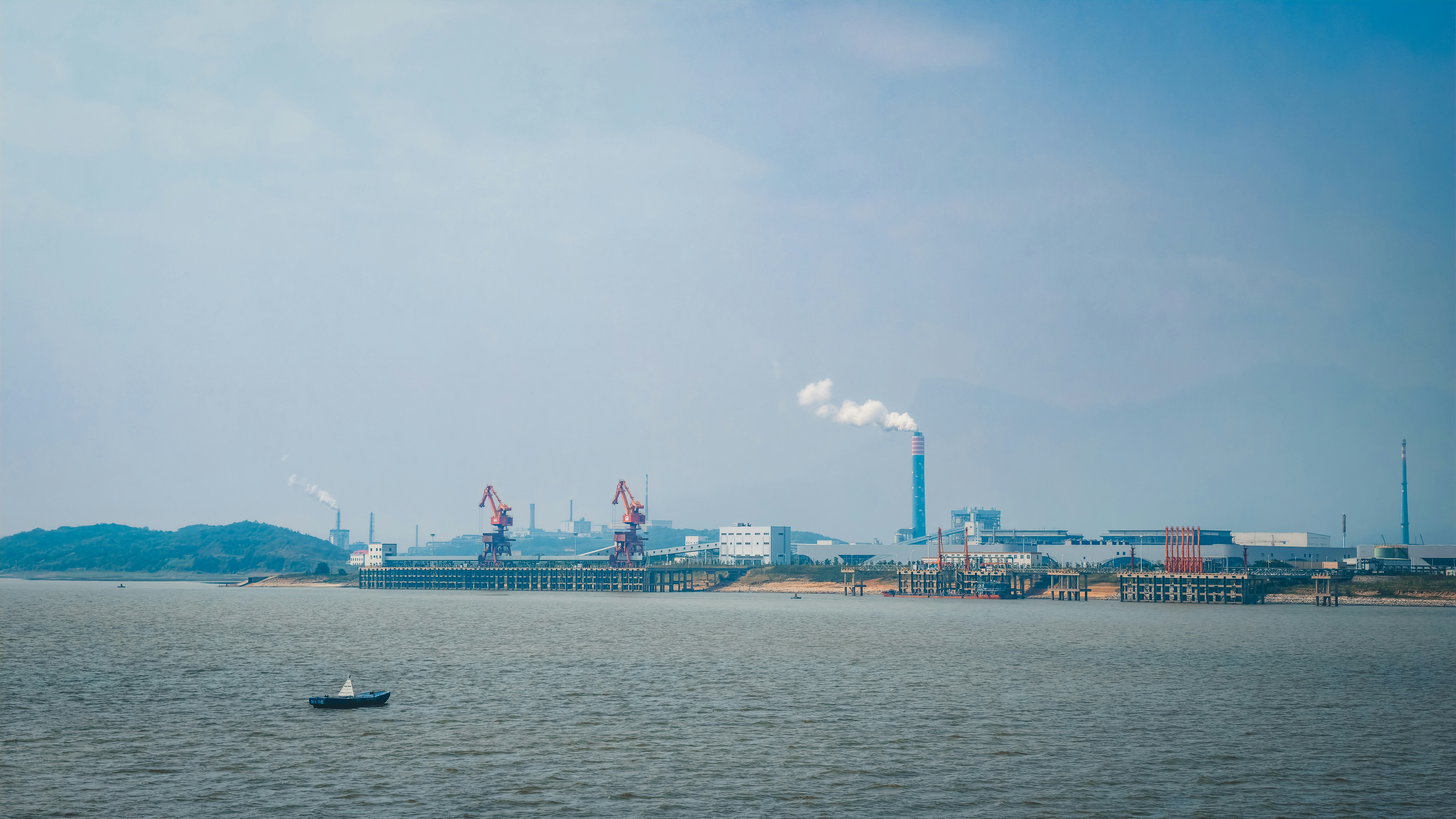 Exposed industrial shoreline across tranquil water